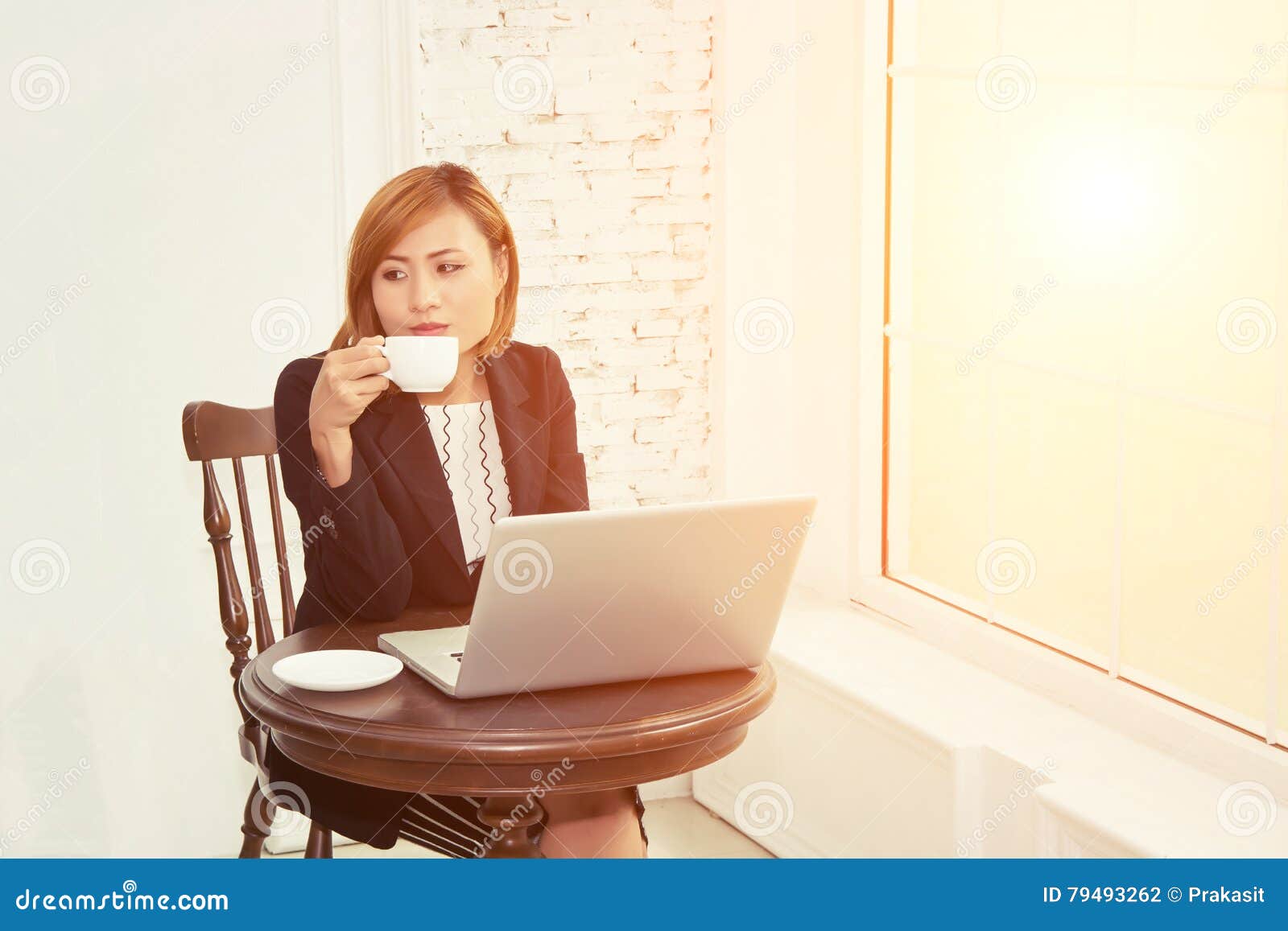 Business Woman Drinking Coffee and Using Laptop in Office Stock Photo ...