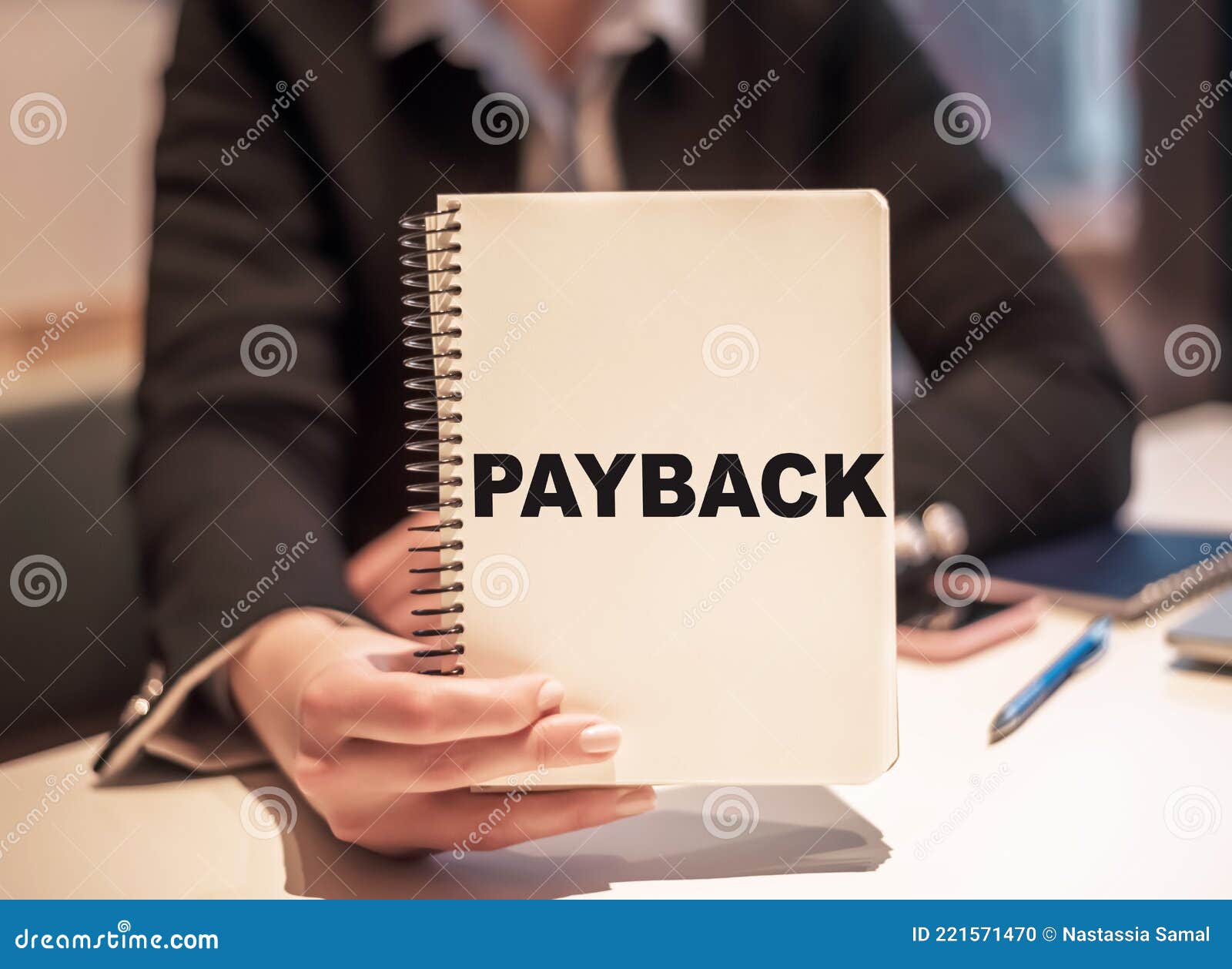 Business Woman Holds a Notebook with the Text PAYBACK Stock Photo ...