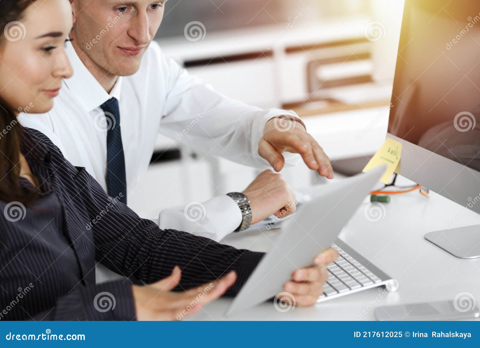 Business Woman and Man Discussing Questions while Using Computer at ...