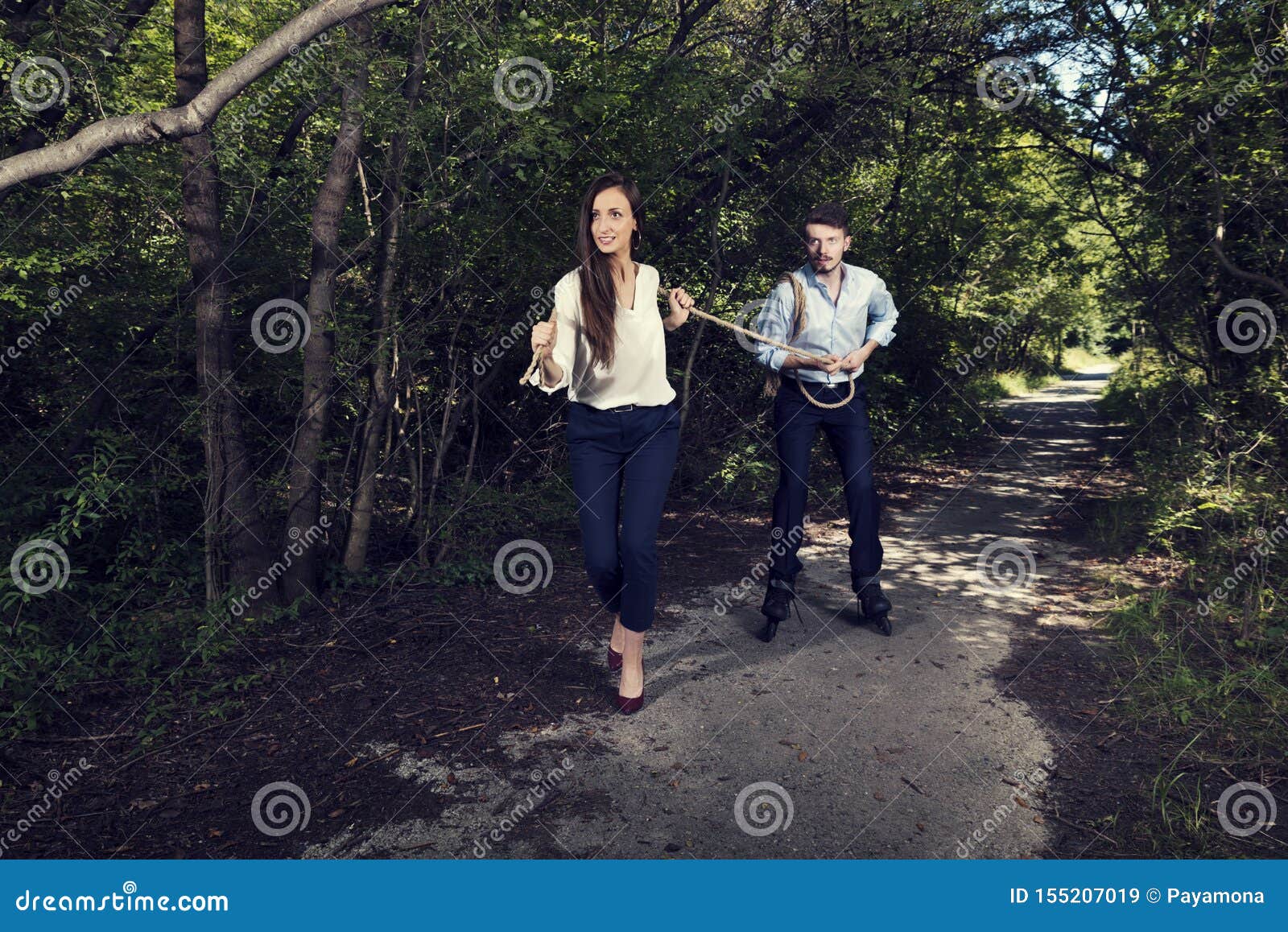 Business Woman Pulling One Business Man with Rope in the City Park ...