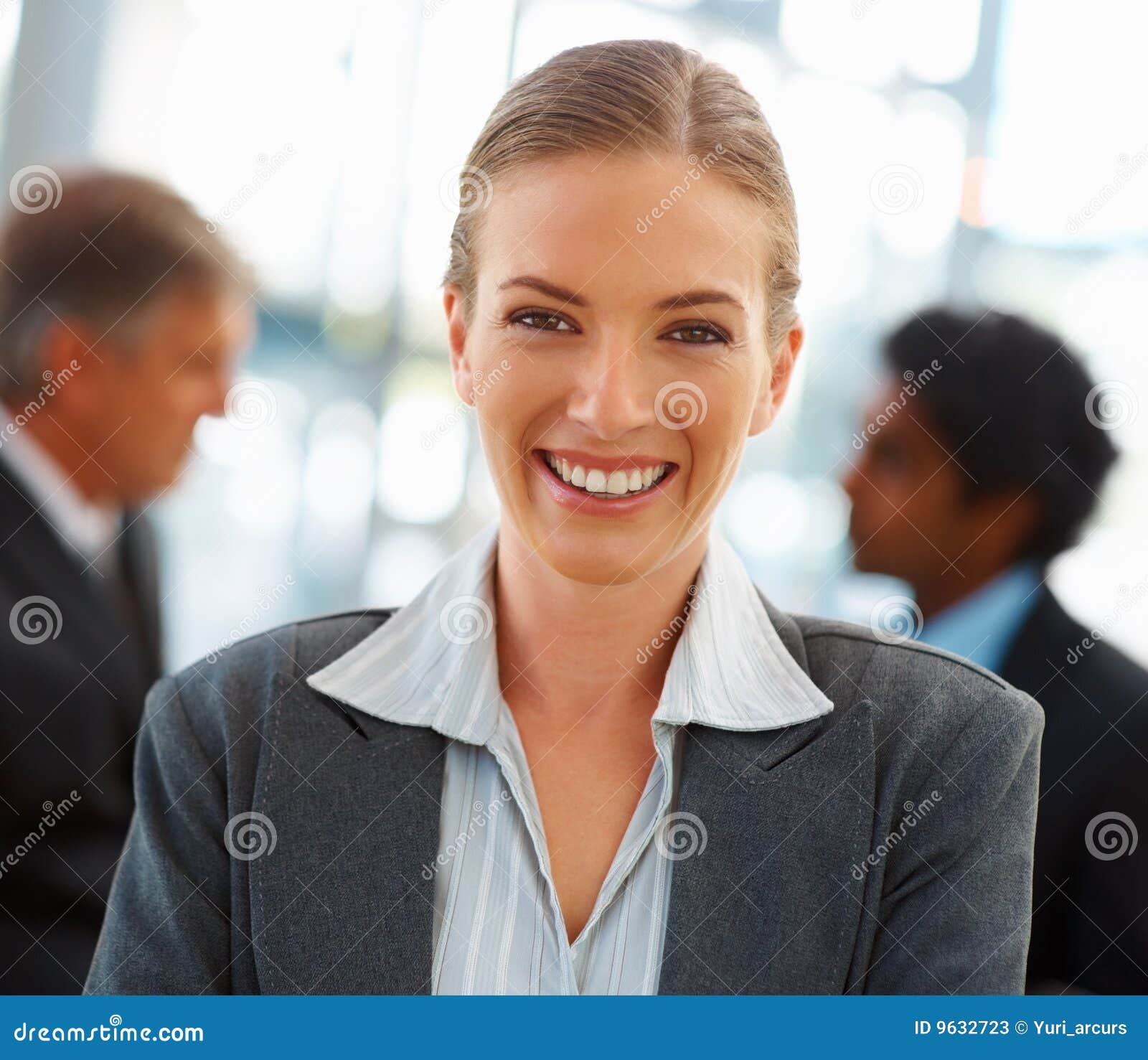Business Woman Smiling with Staff at the Back Stock Image - Image of ...