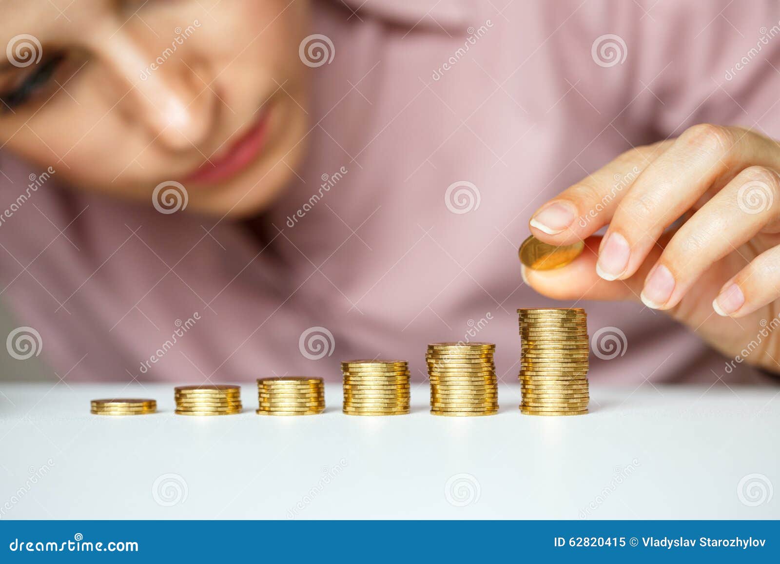 Business Woman Stacking Gold Coins into Increasing Columns Stock Image ...
