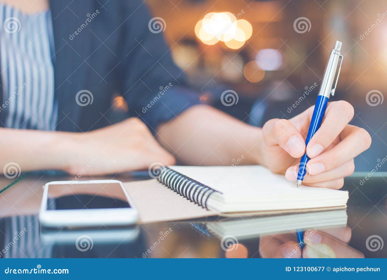 Business Woman is Taking Notes on a Note Pad with a Pen in the O Stock ...