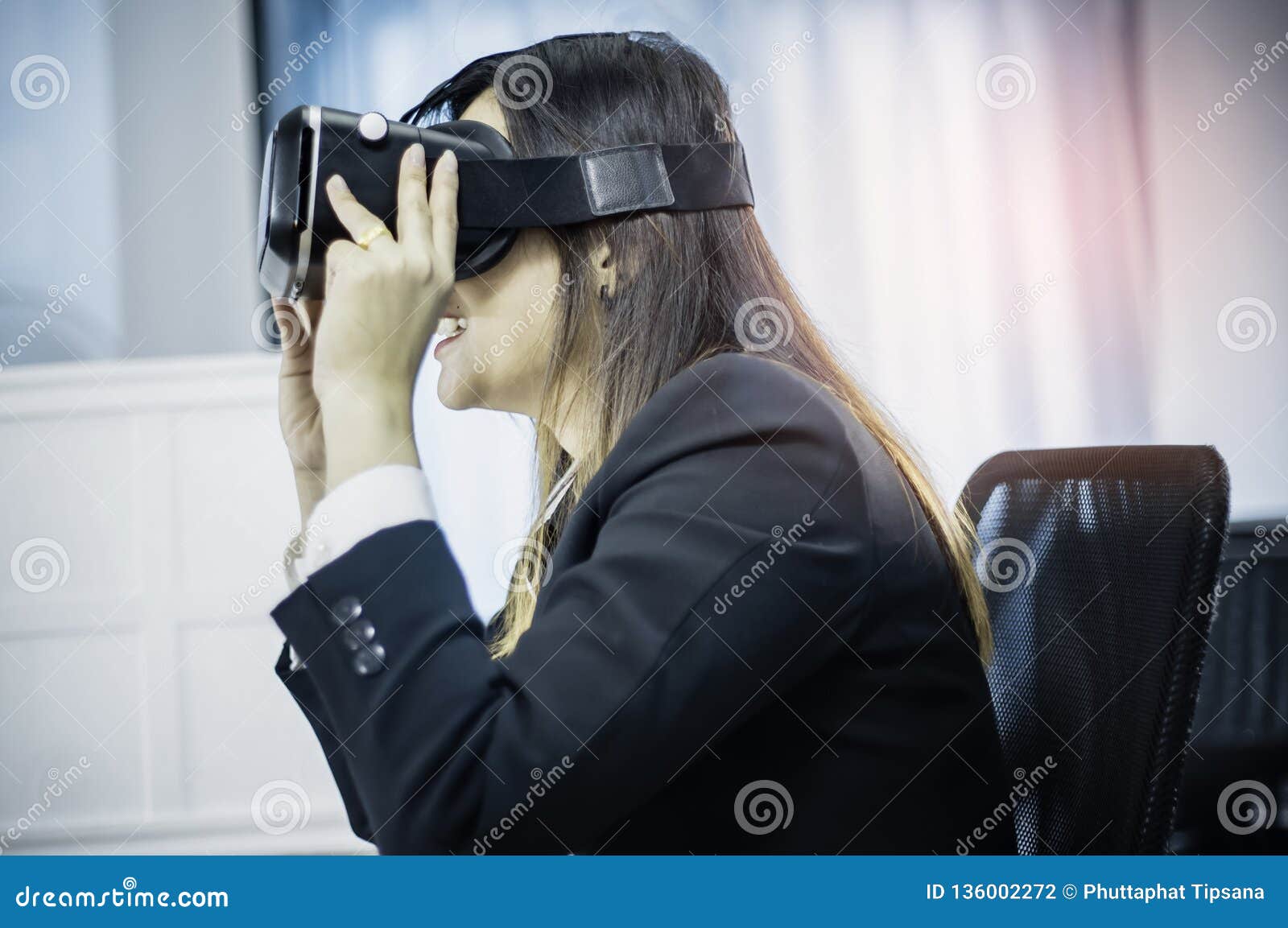Business Woman Using a VR Headset for Work with Virtual Reality, with ...