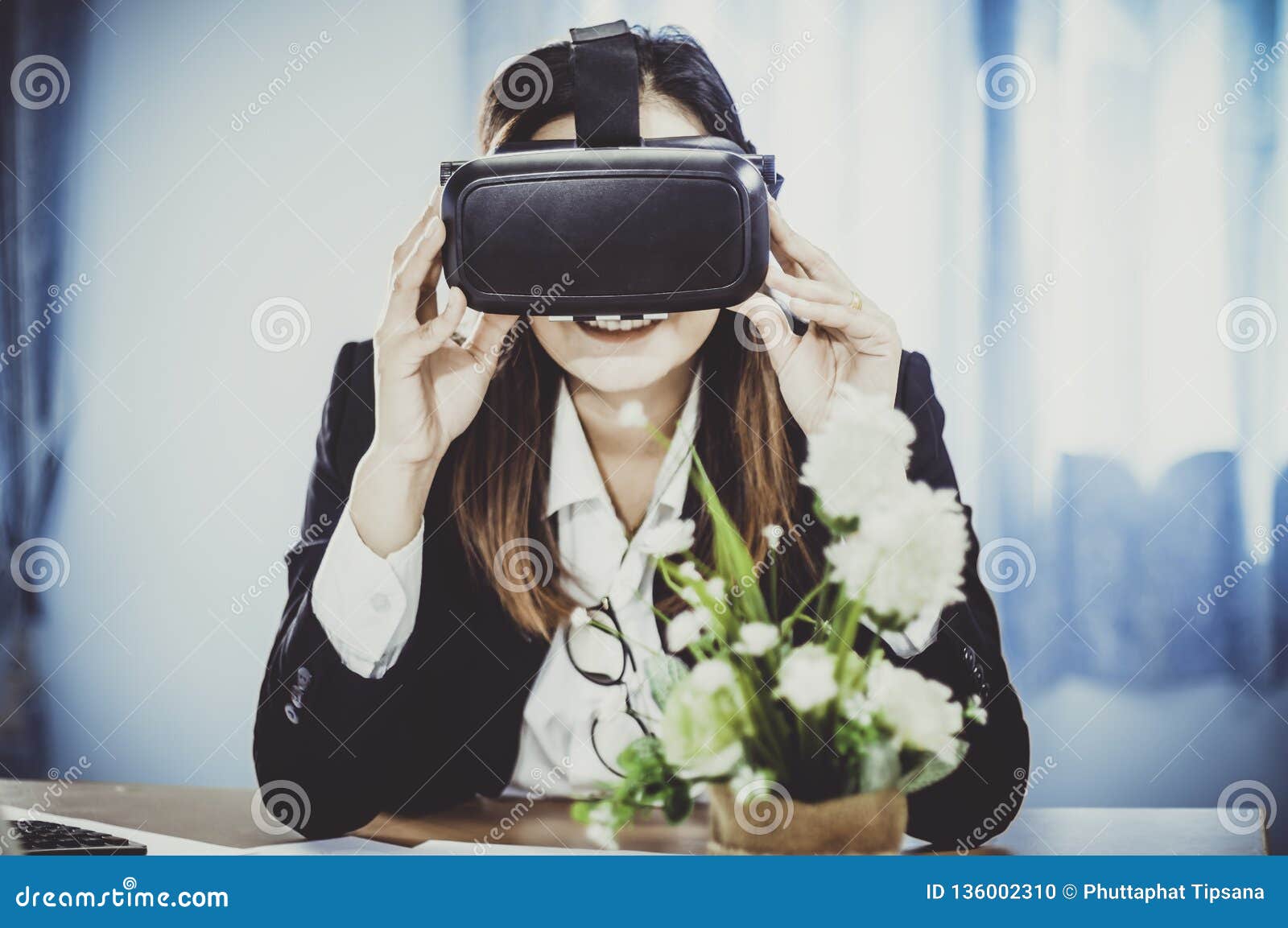 Business Woman Using a VR Headset for Work with Virtual Reality, with ...