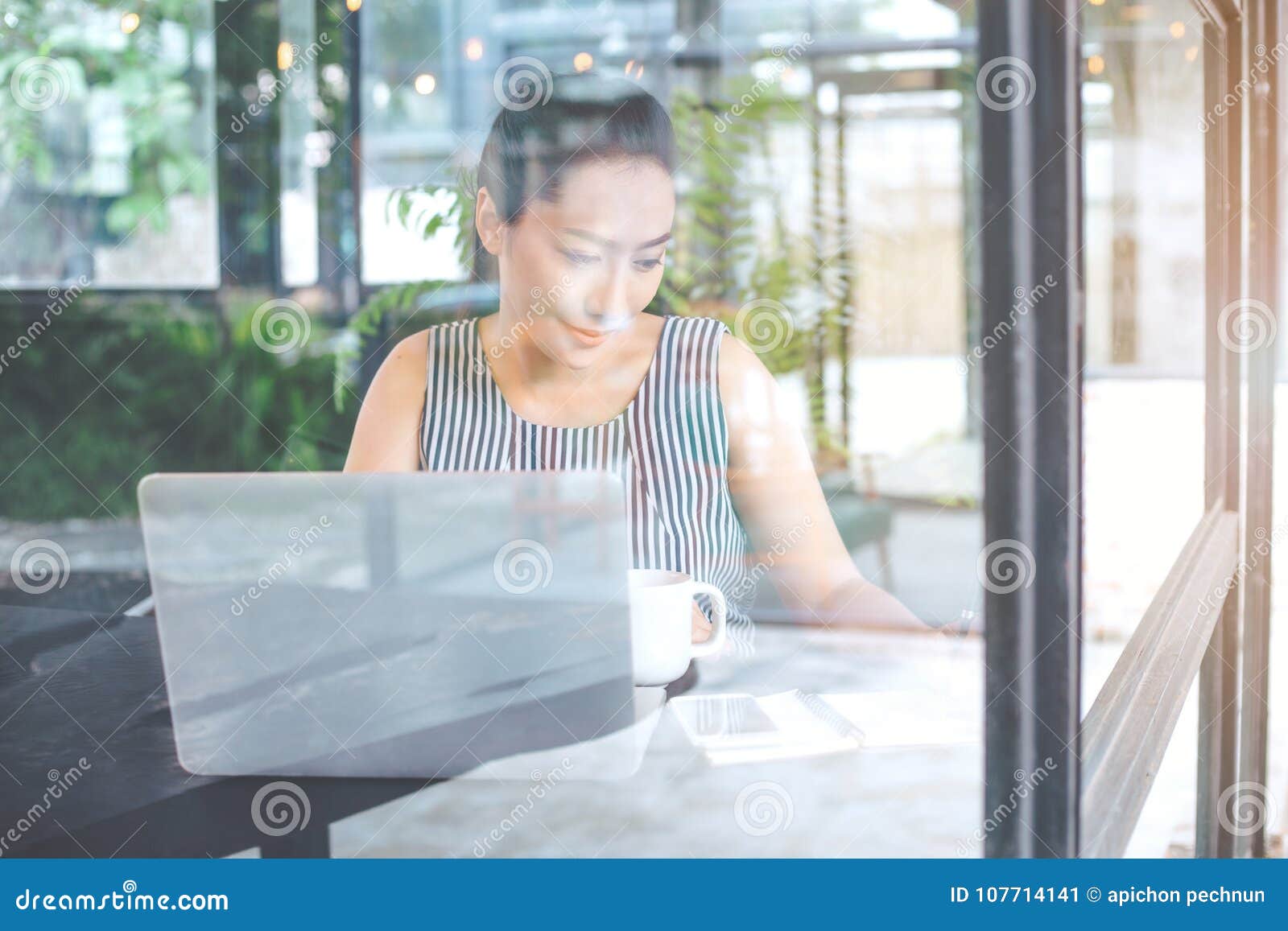 Business Woman Working with a Laptop Computer and Writing Notebook in ...
