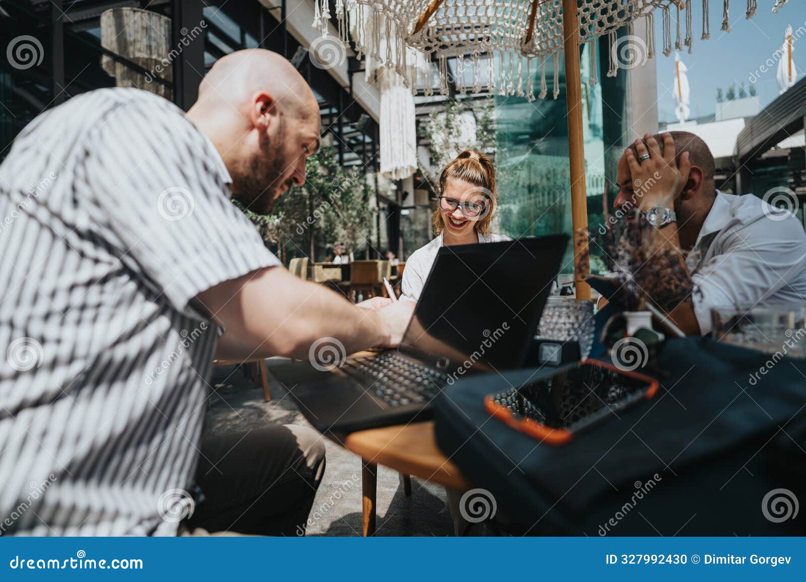 Business Workers Collaborating on a Project in a Coffee Bar ...