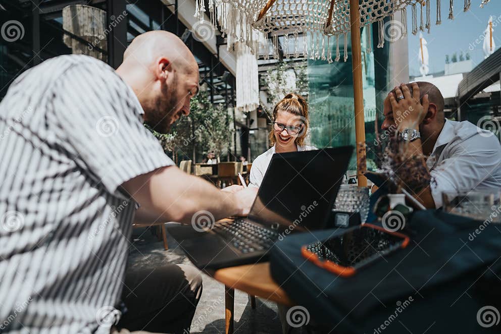 Business Workers Collaborating on a Project in a Coffee Bar ...
