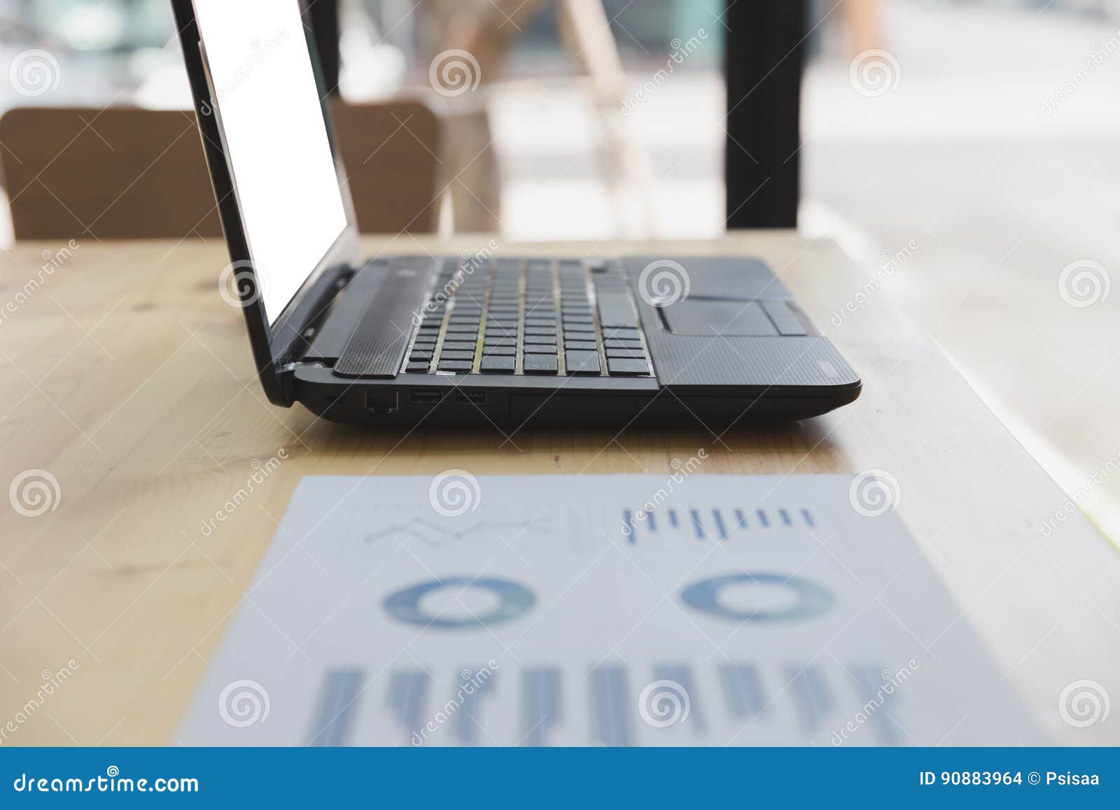 Business Workplace with Laptop Computer and Paper with Graphs an Stock ...