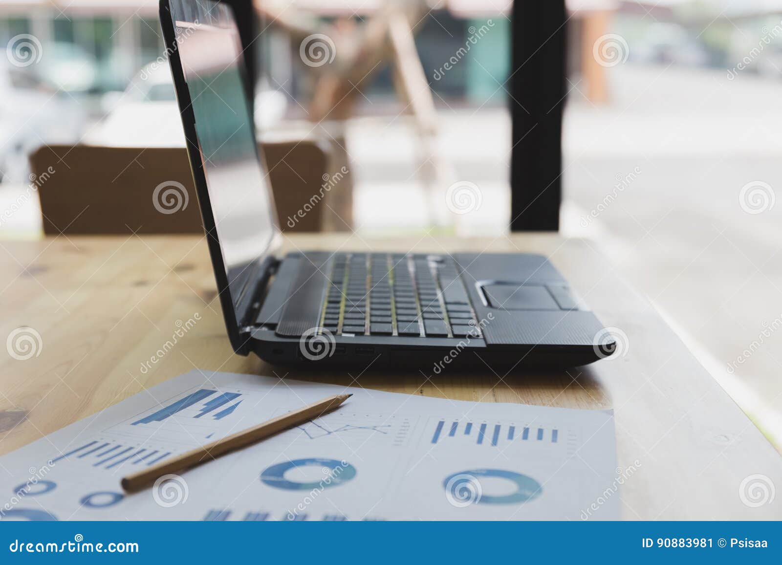 Business Workplace with Laptop Computer and Paper with Graphs an Stock ...