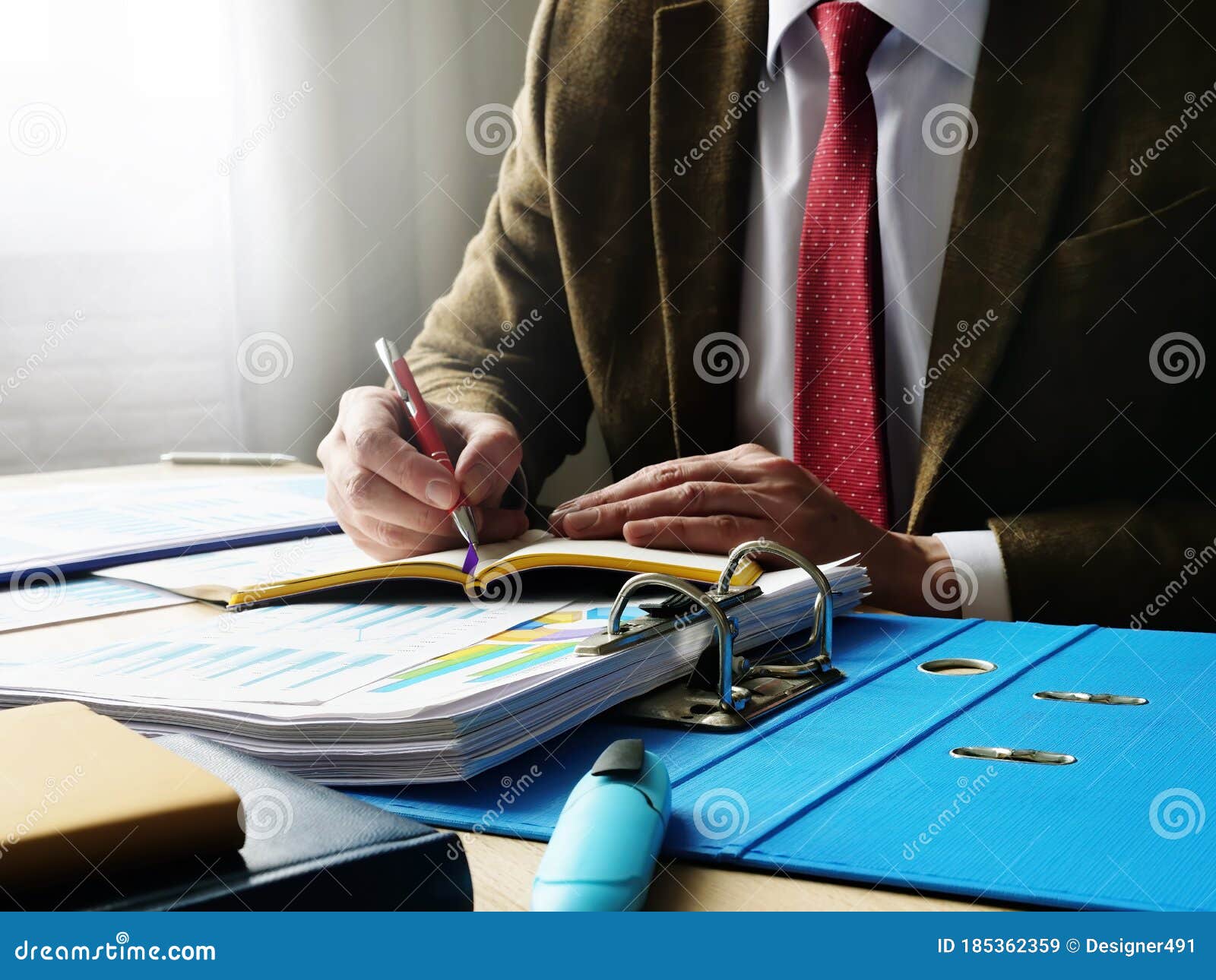Businessman or Accountant Makes Notes in a Notebook. Paperwork with ...