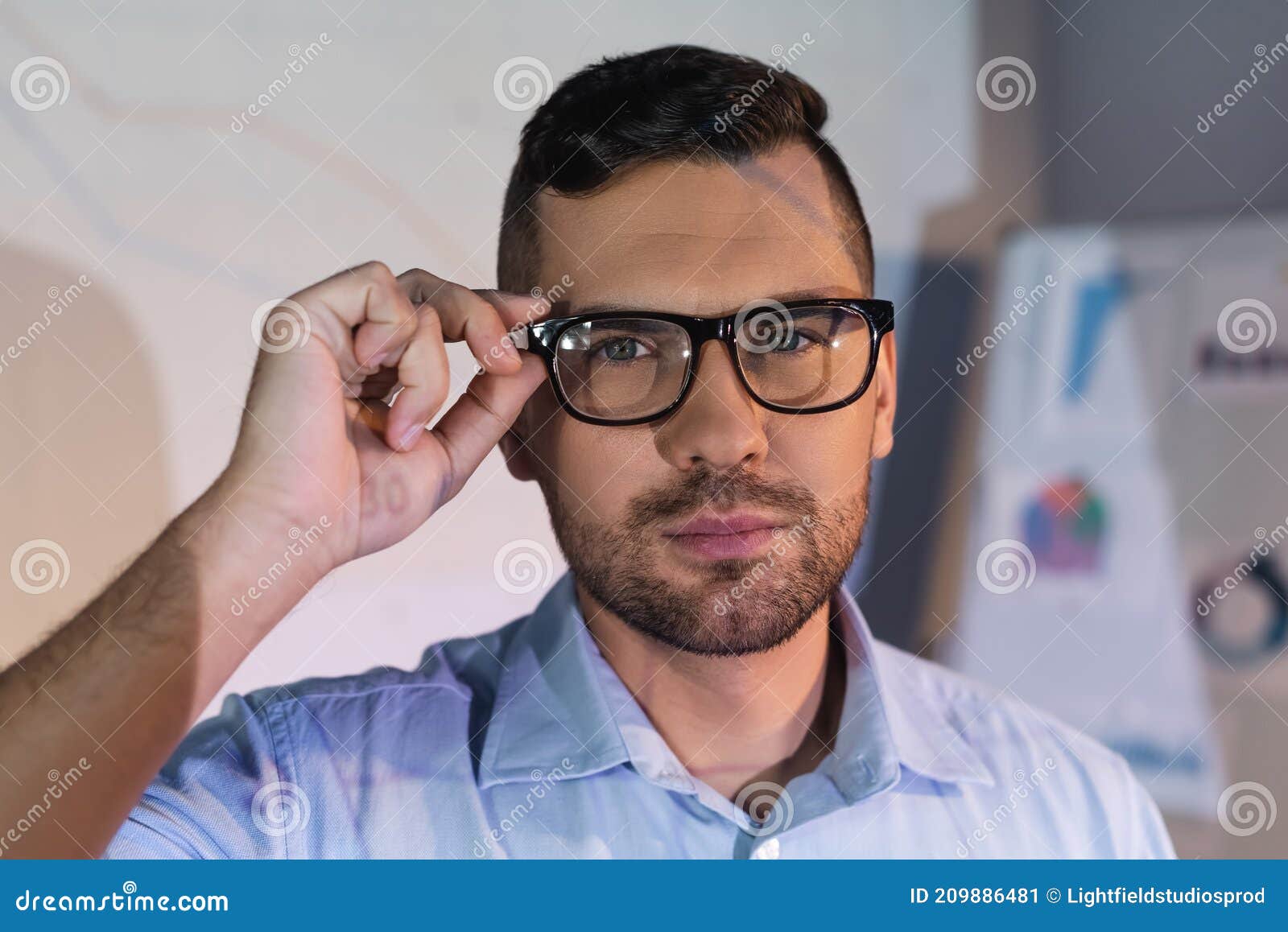 Businessman Adjusting Glasses And Looking At Stock Image Image Of