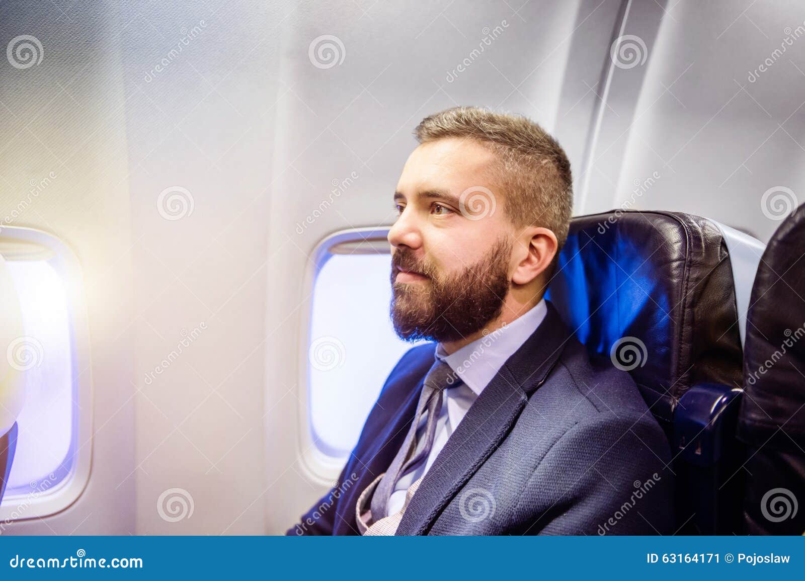 Businessman in airplane stock image. Image of interior - 63164171