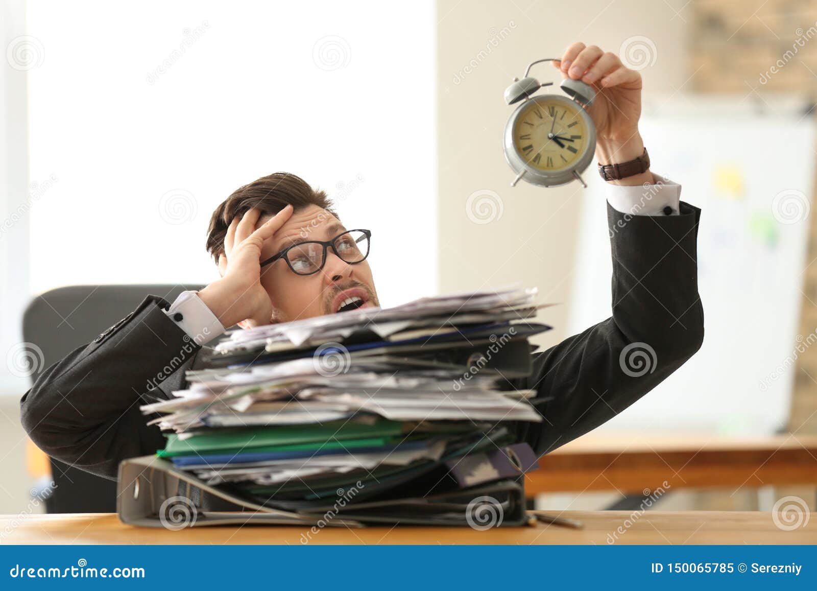 Businessman with Alarm Clock and Stack of Documents in Office. Time ...
