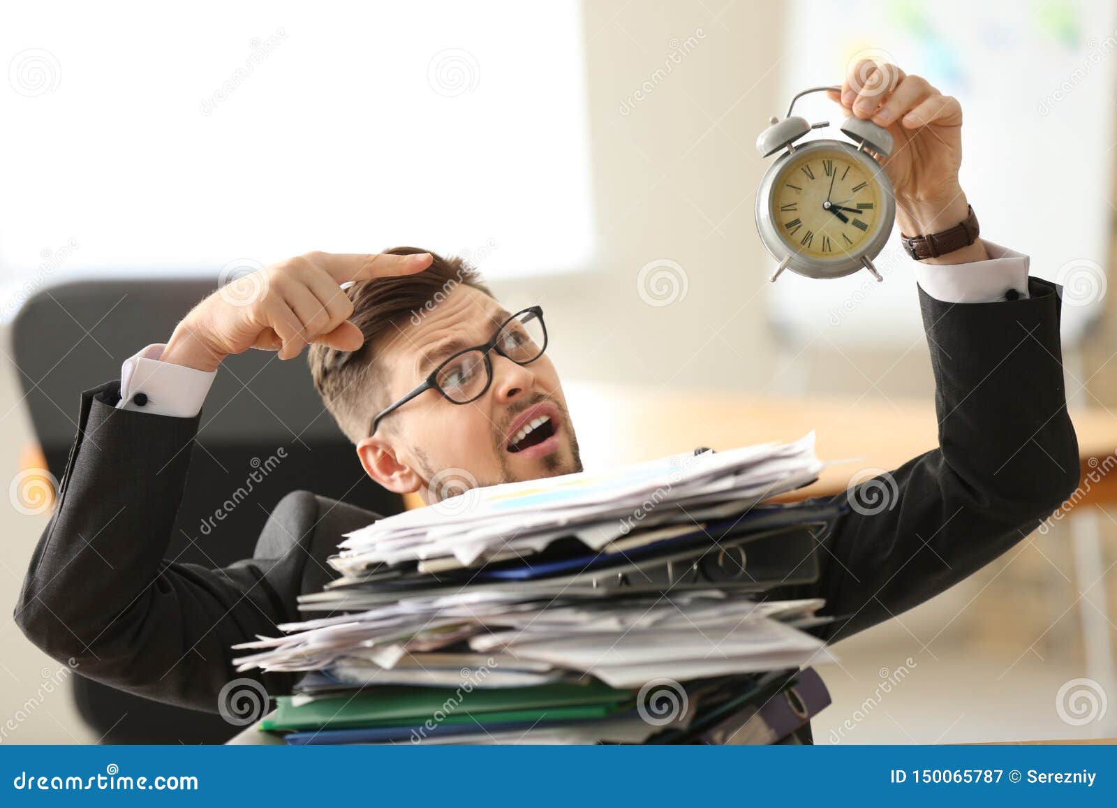Businessman with Alarm Clock and Stack of Documents in Office. Time ...