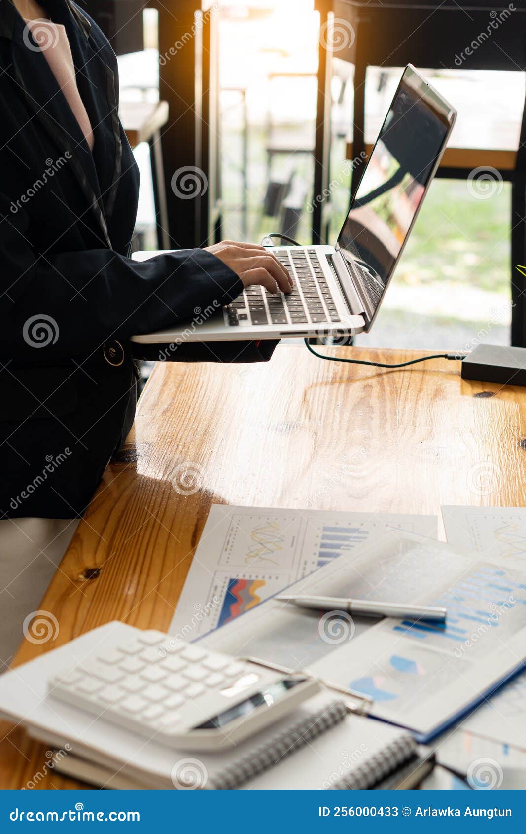 Businessman Analyzing Finances with Documents, Graphs, Accounts and ...