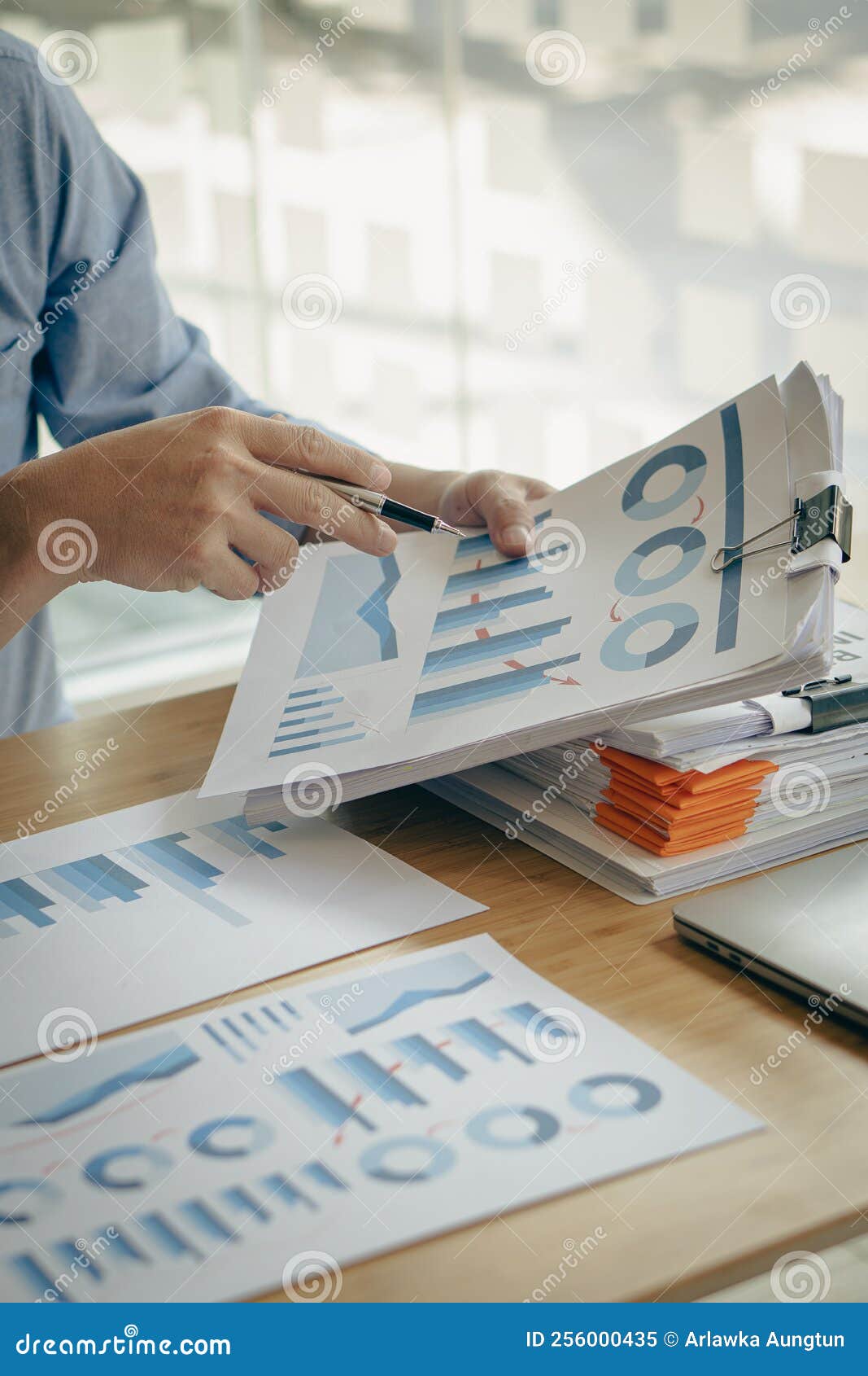 Businessman Analyzing Finances with Documents, Graphs, Accounts and ...