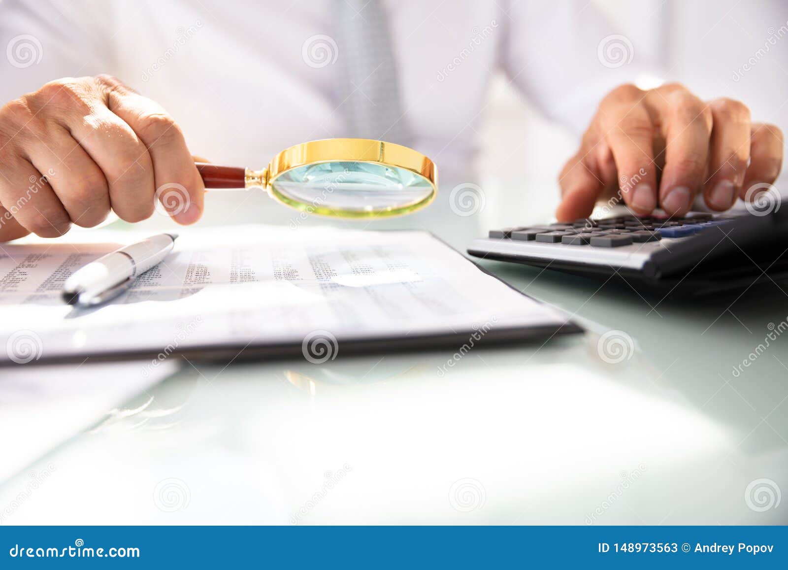 Businessman Analyzing Financial Report with Magnifying Glass Stock ...