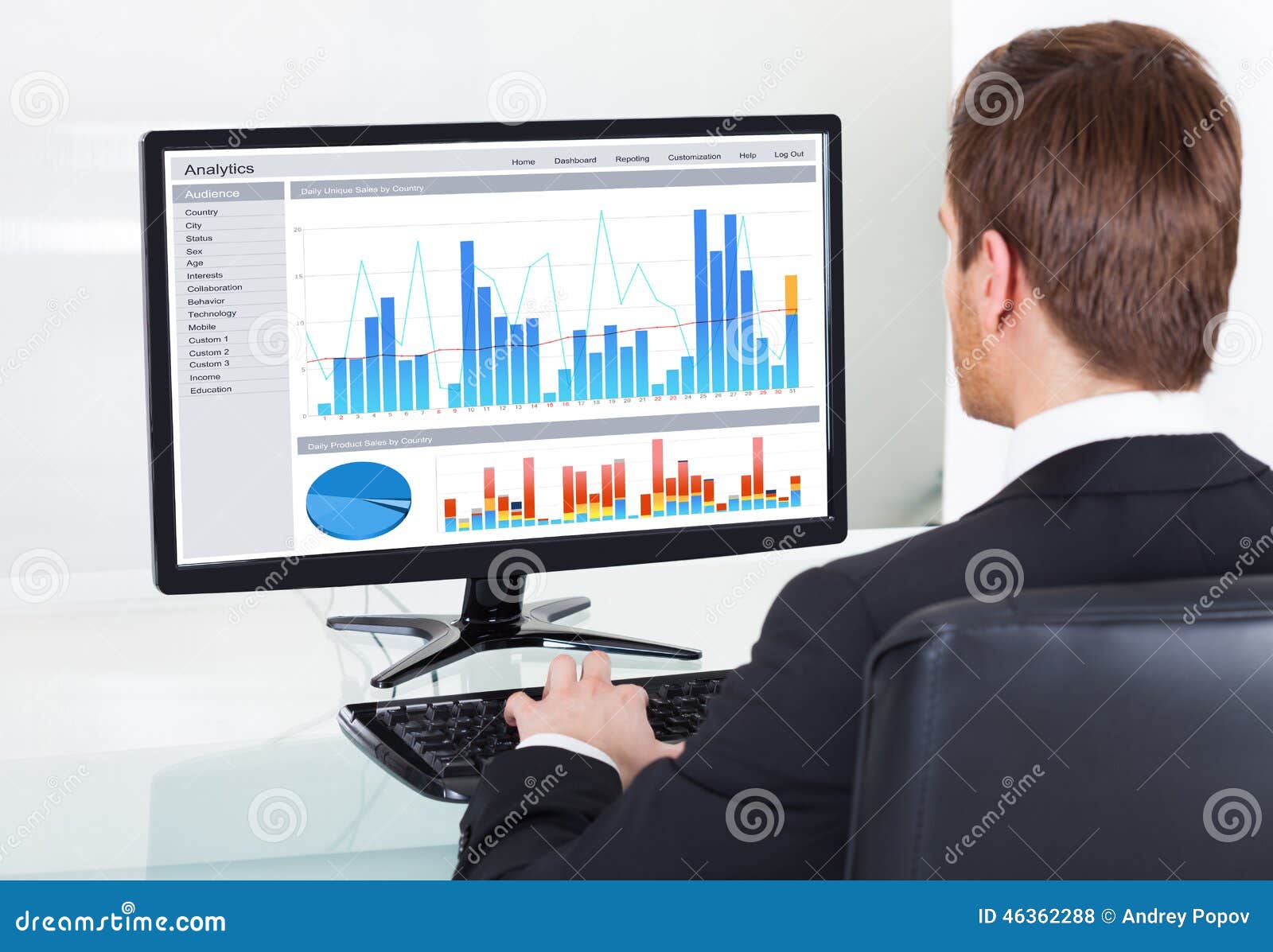 Businessman Analyzing Graphs on Computer at Desk Stock Photo - Image of ...