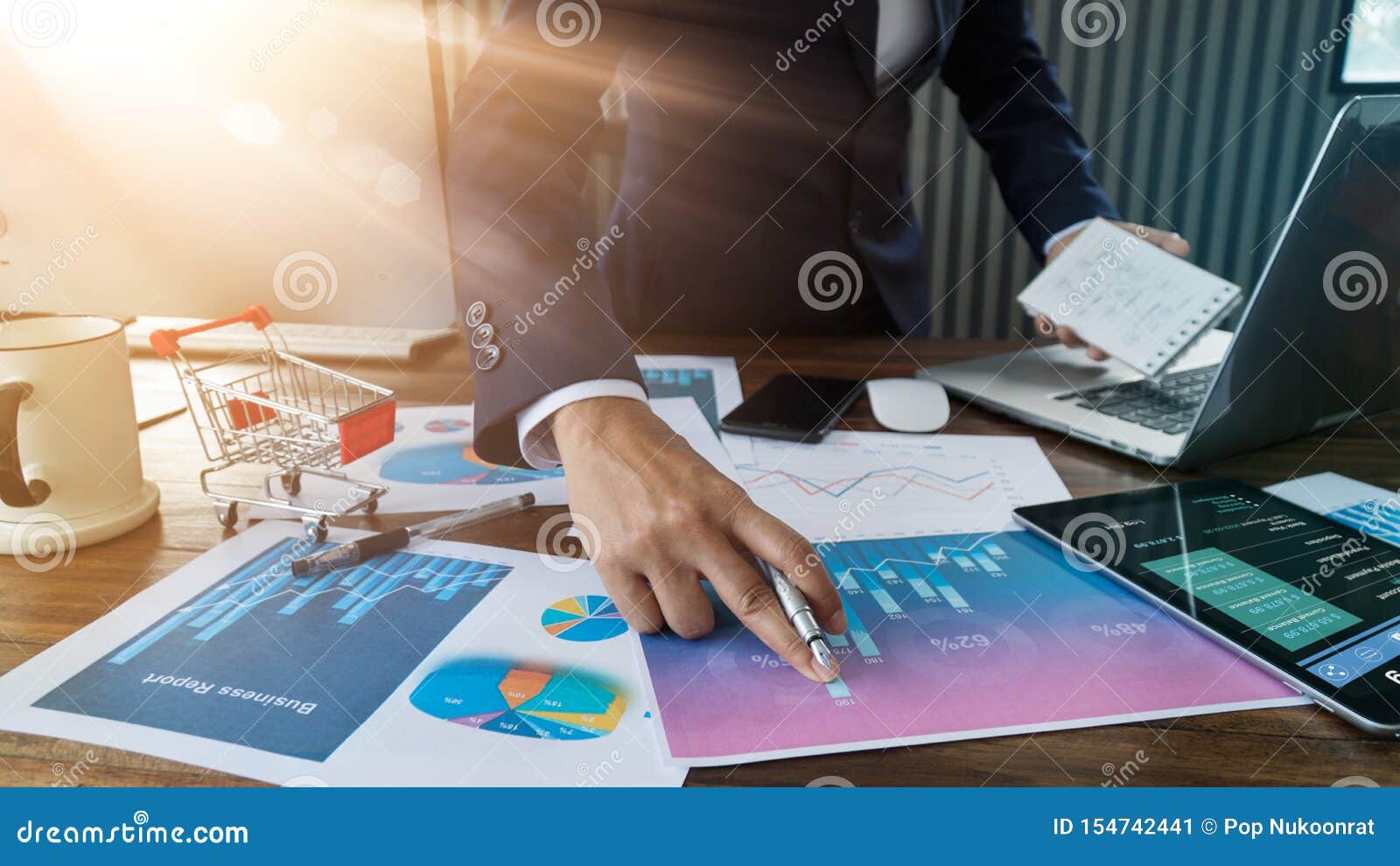 Businessman Analyzing Sales Data and Economic Growth and Pointing at ... Businessman Analyzing Sales Data and Economic Growth and Pointing at ...
