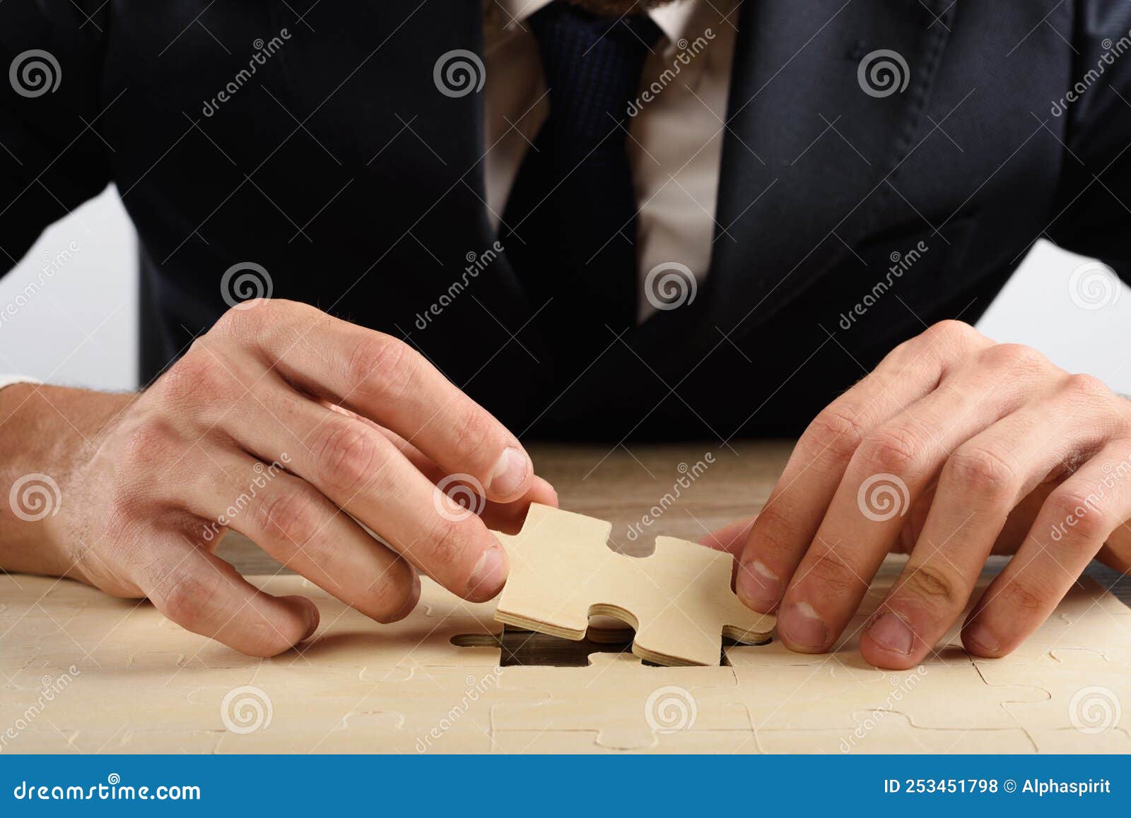 Businessman Applies the Last Part of a Missing Puzzle Stock Photo ...