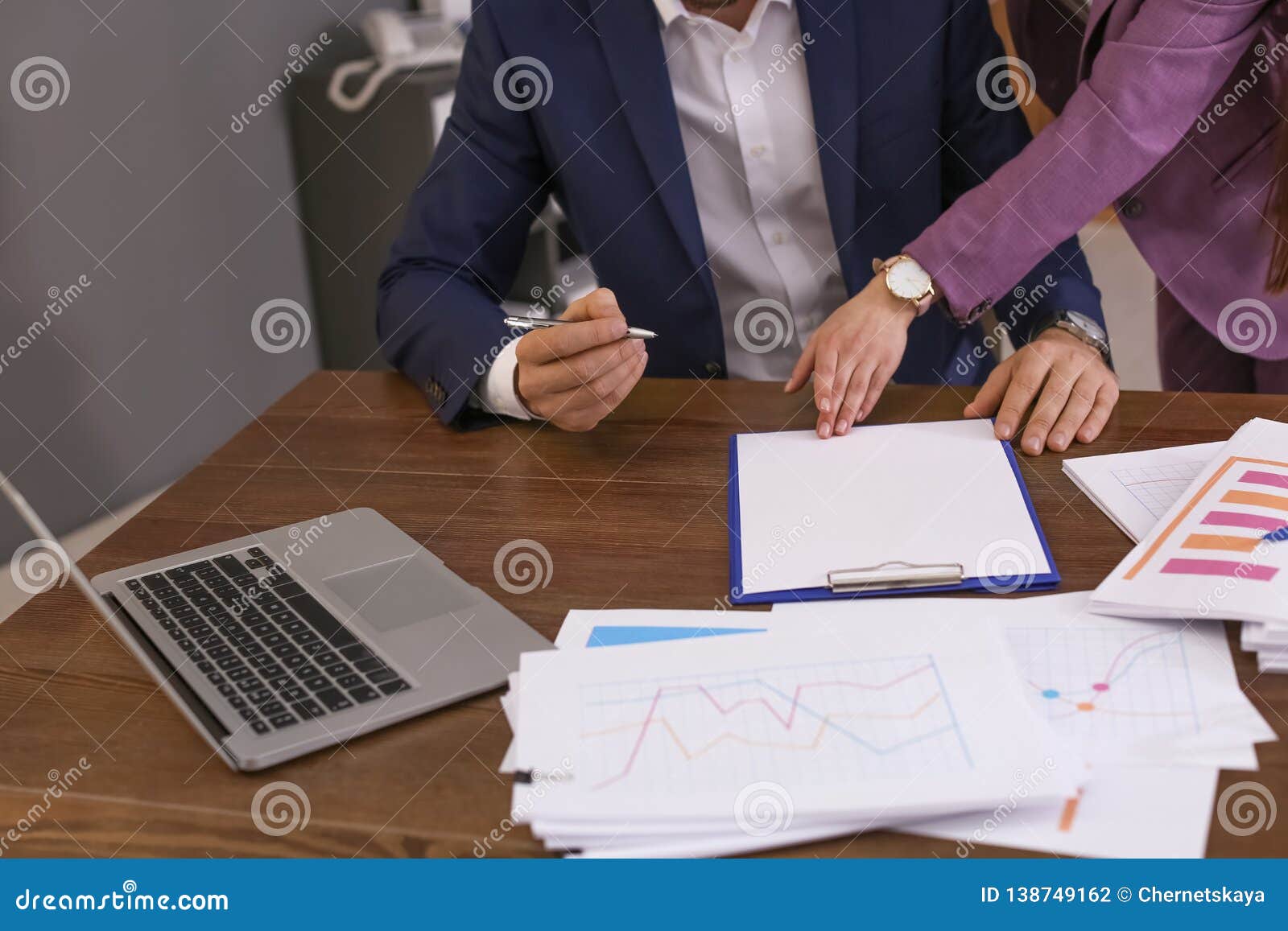 Businessman and Assistant Working with Documents at Table Stock Photo ...
