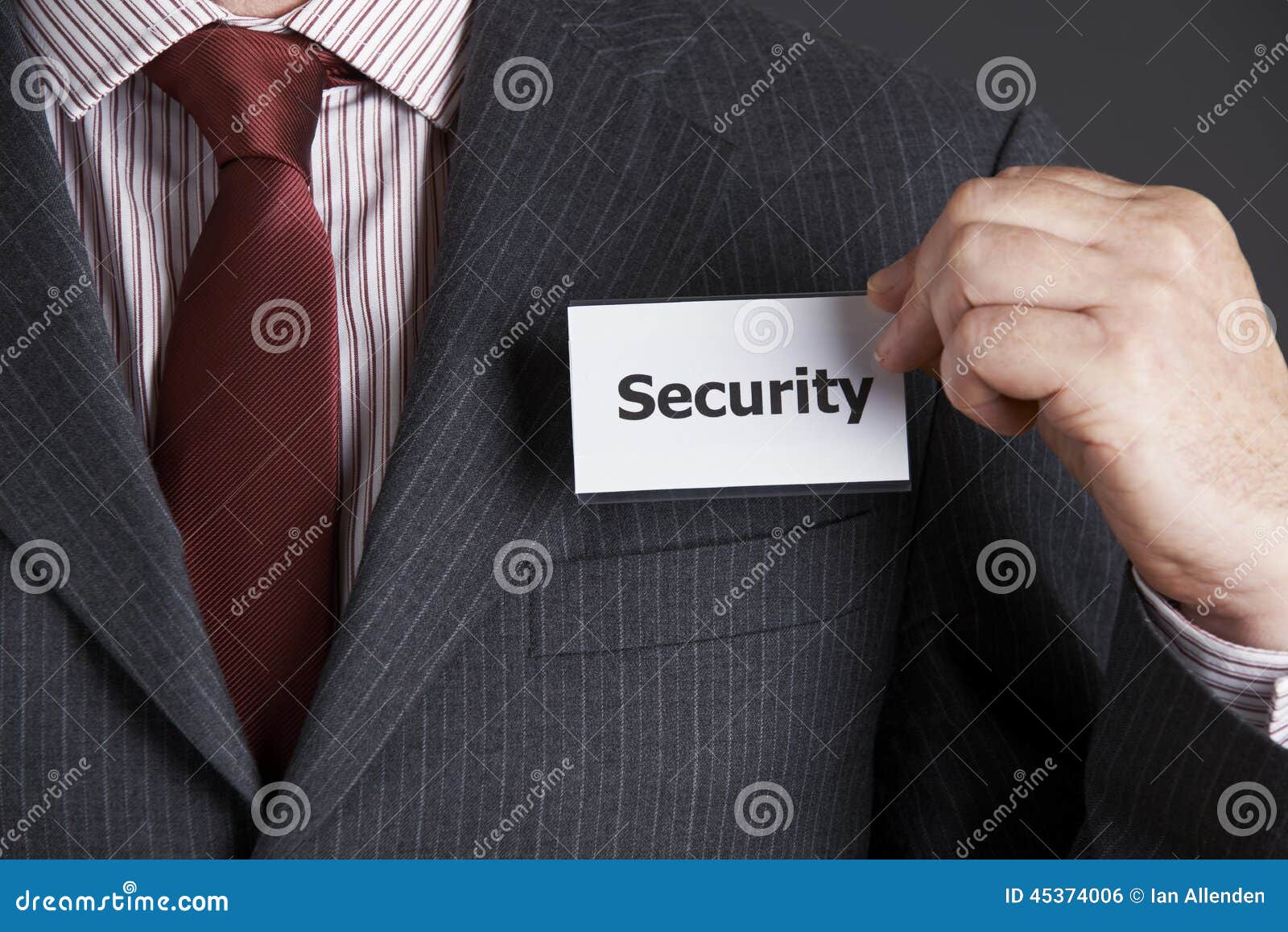 Businessman Attaching Security Badge To Jacket Stock Photo - Image of ...
