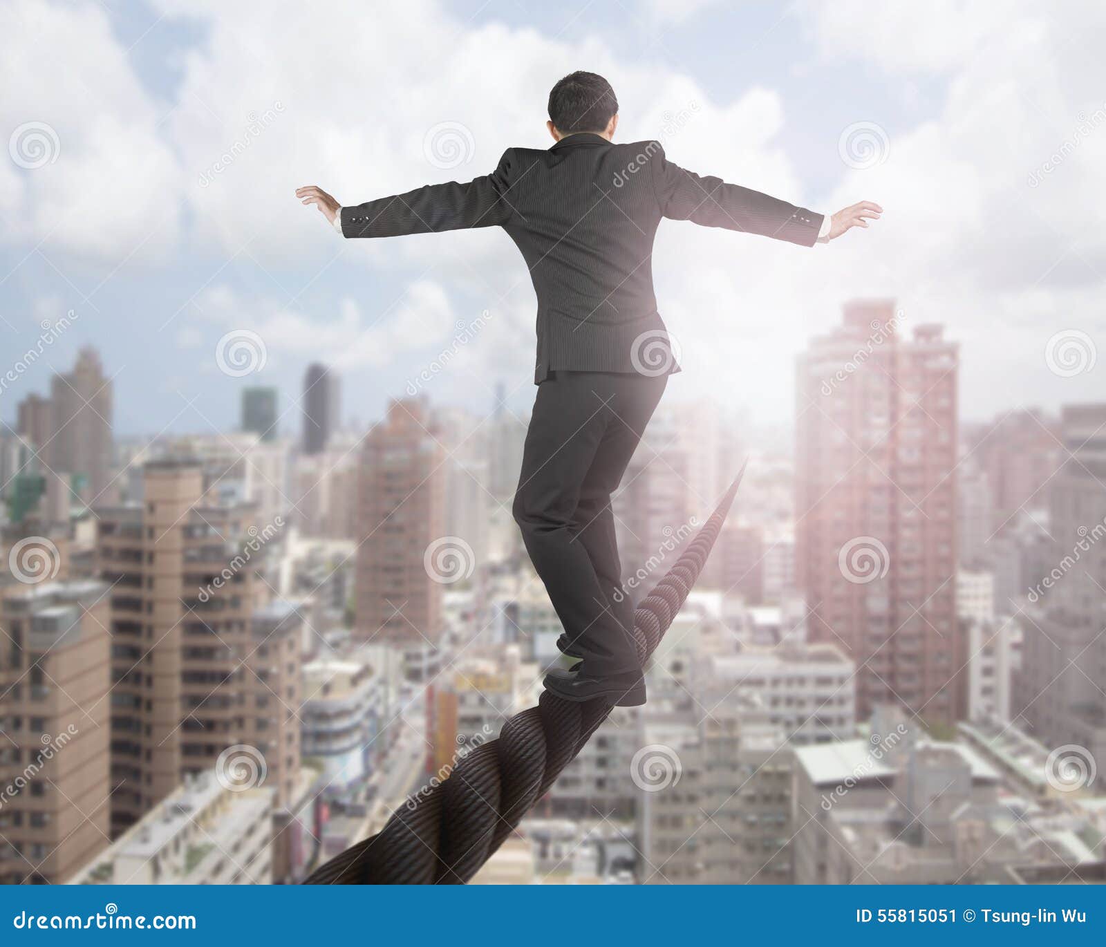Businessman Balancing on a Wire with Sky Clouds Cityscape Stock Image ...