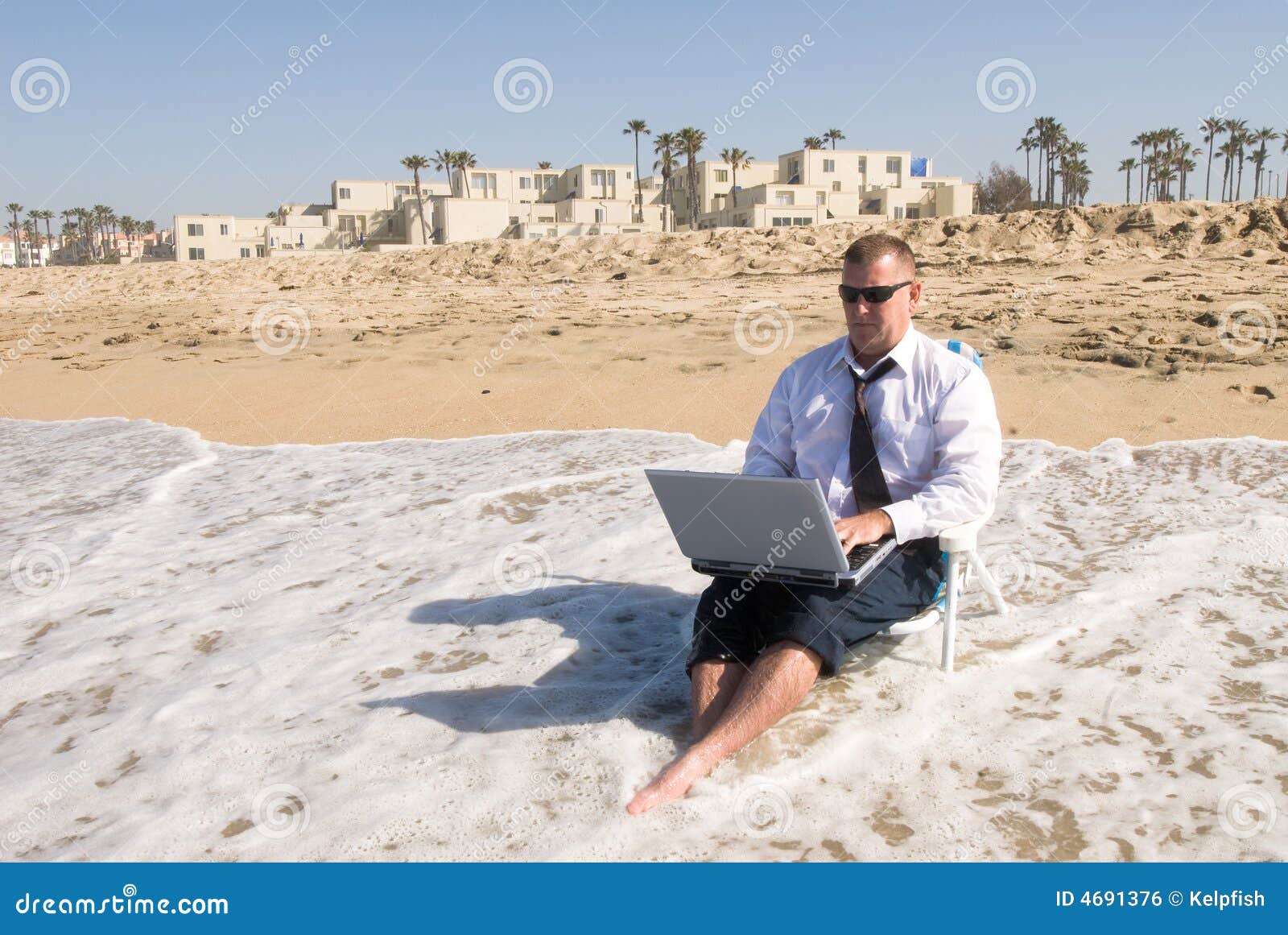 Businessman on Beach Working Stock Photo - Image of sand, beach: 4691376