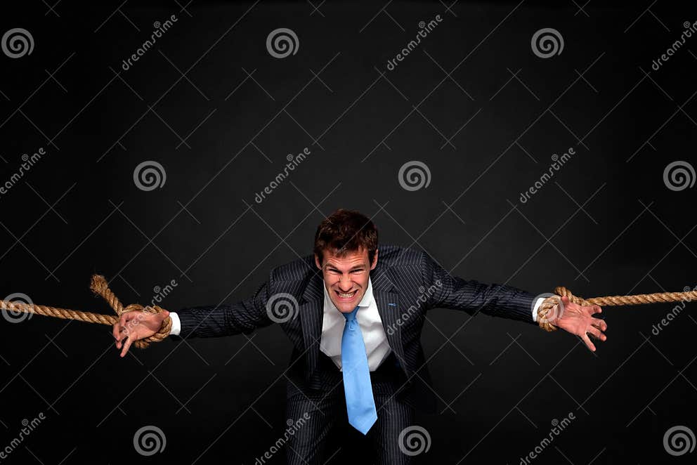 Businessman Being Pulled by Rope on Both Sides. Stock Photo - Image of ...