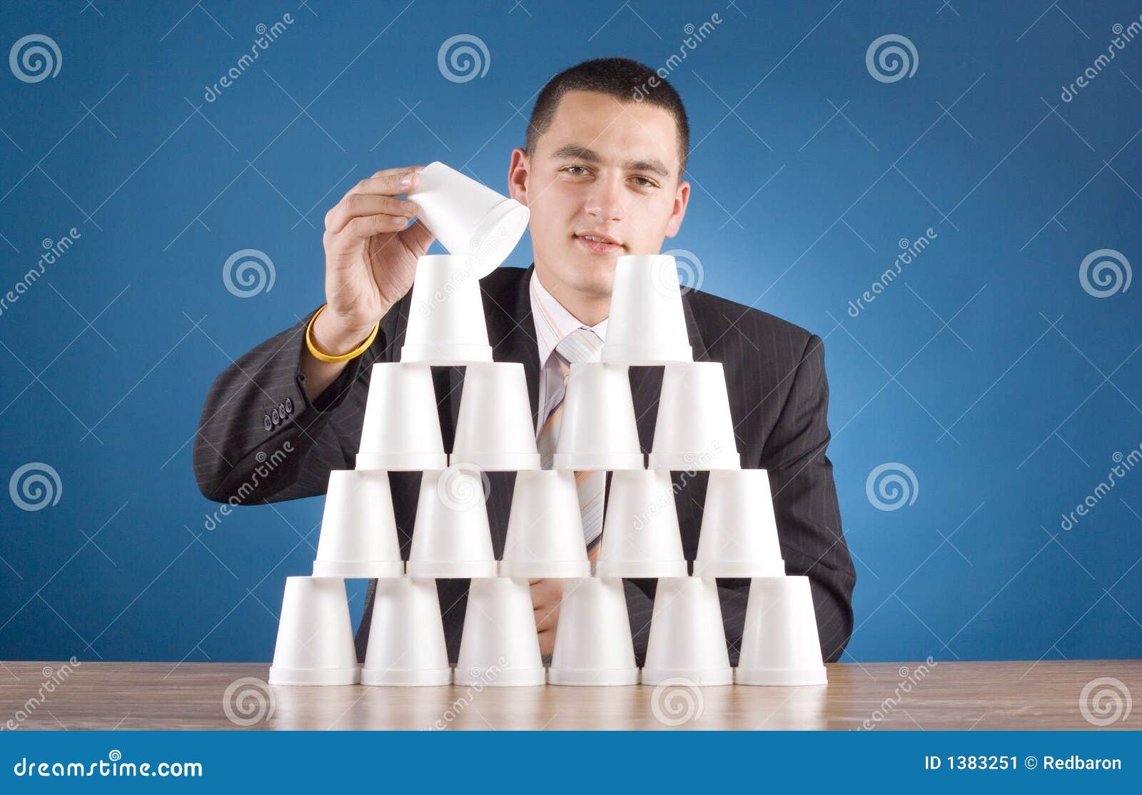Businessman Building Cups Pyramid Stock Image - Image of commerce ...