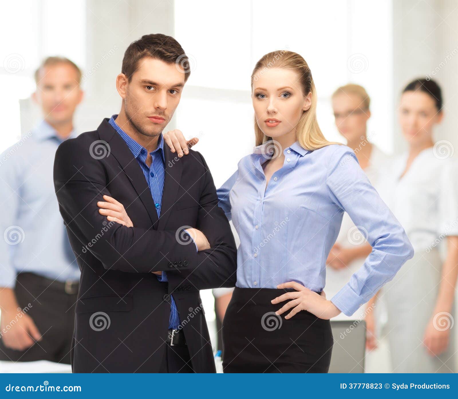 Businessman and Businesswoman in the Front of Team Stock Image - Image ...
