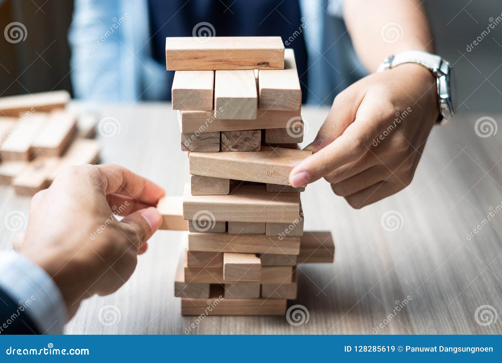 Businessman And Businesswoman Hand Placing Or Pulling Wooden Block ... Businessman And Businesswoman Hand Placing Or Pulling Wooden Block ...