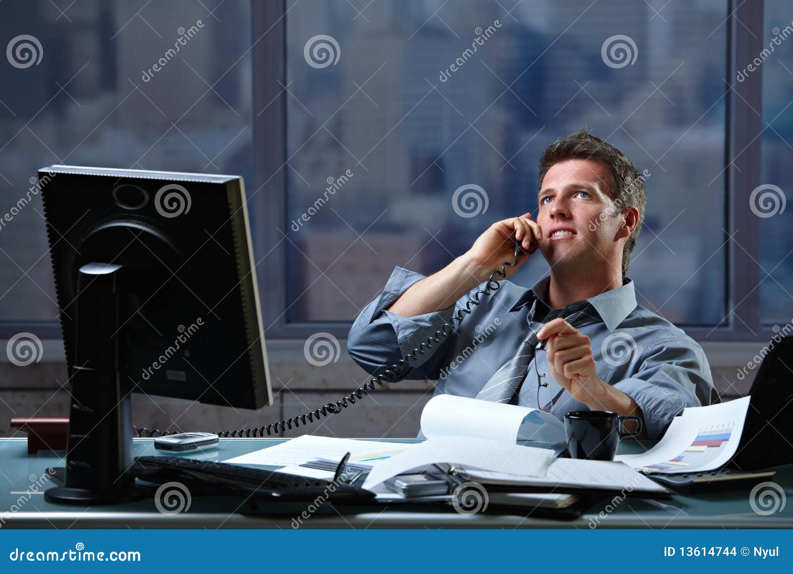 Businessman Calling on Landline at Office Stock Photo - Image of ...