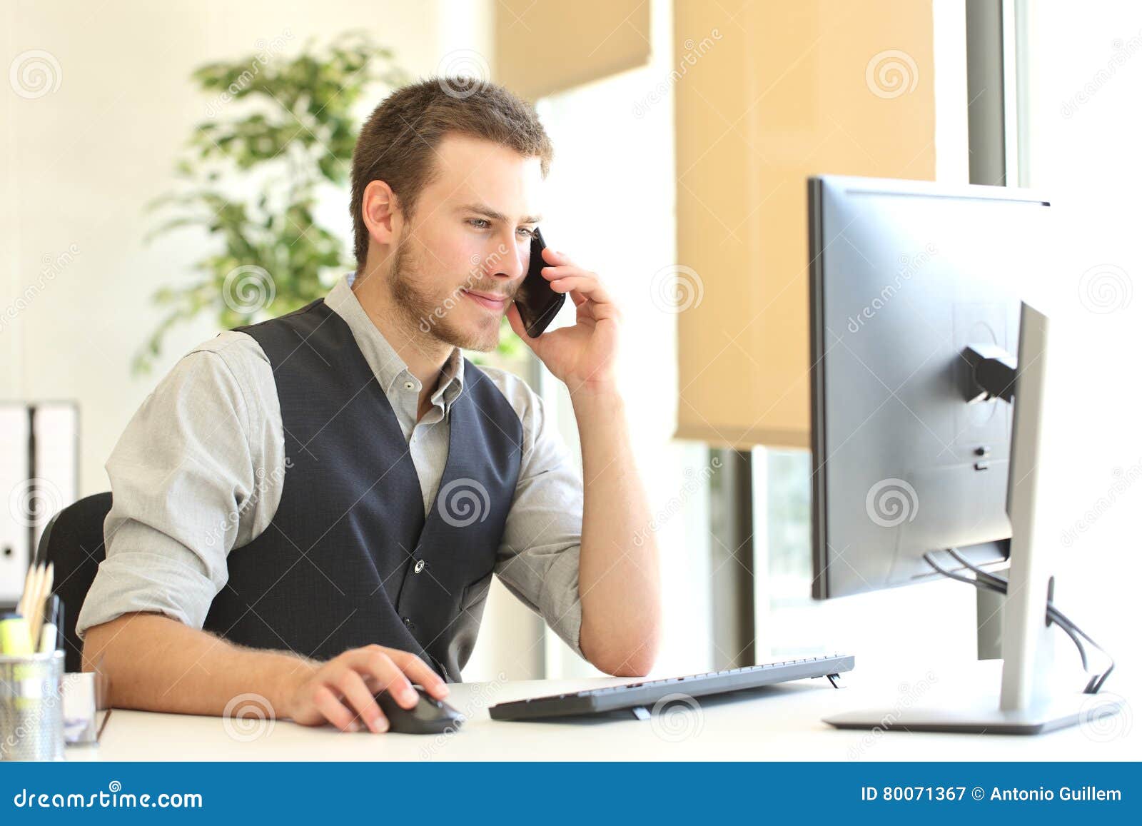 Businessman Calling on Phone and Using a Computer Stock Image - Image ...