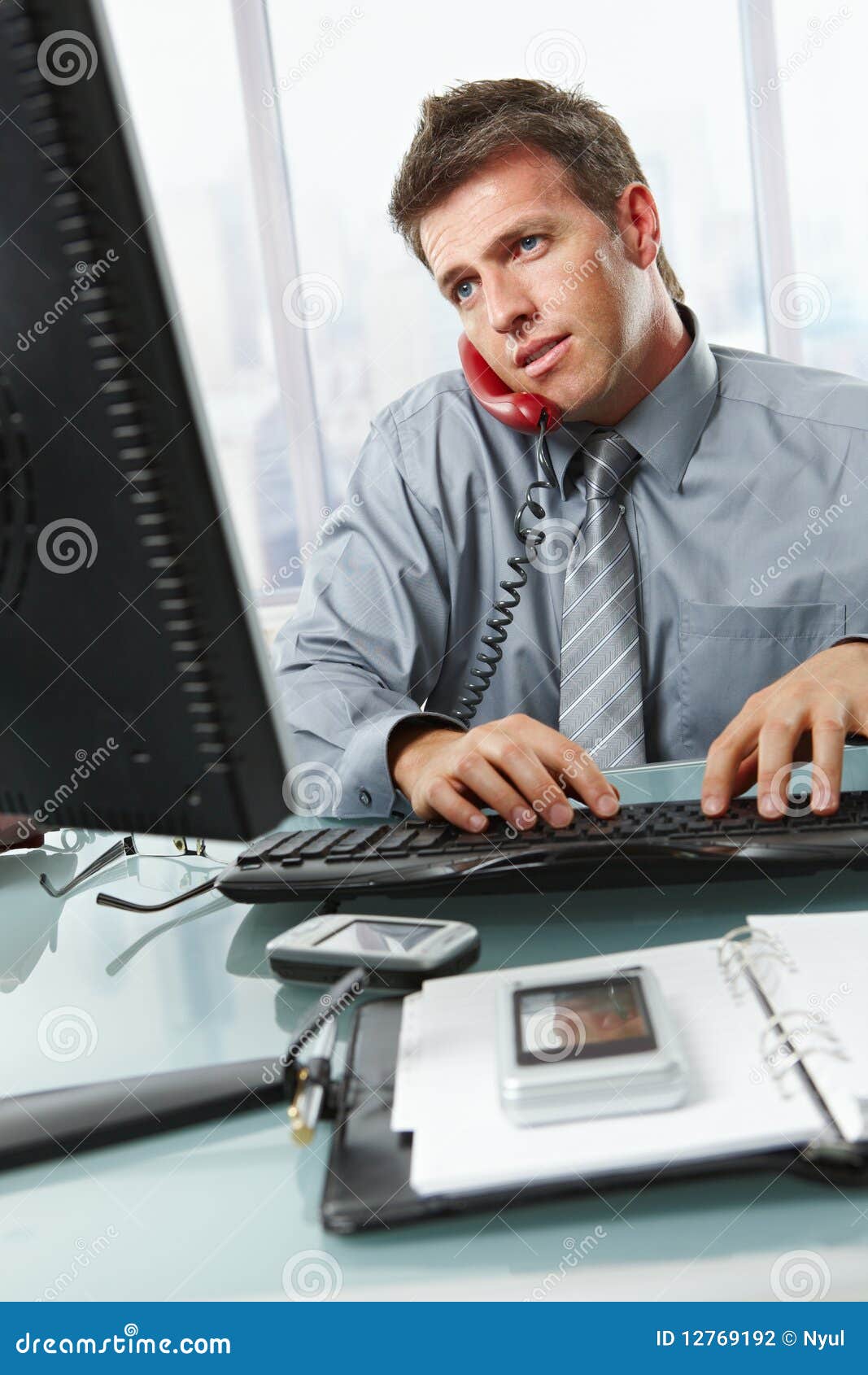 Businessman Calling Typing in Office Stock Photo - Image of goodlooking ...