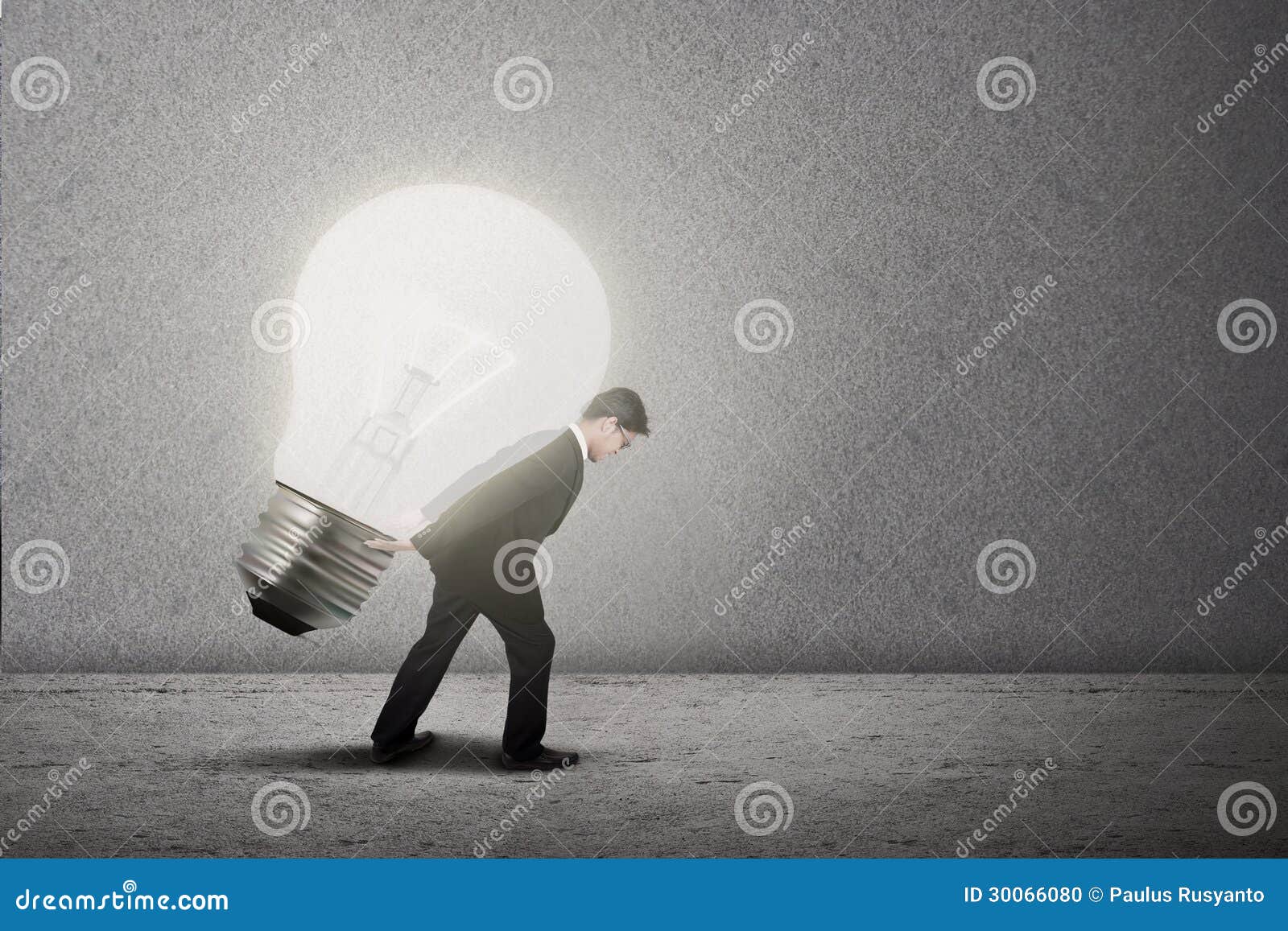 Businessman Carry Bright Light Bulb Stock Photo - Image of grey, bulb ...