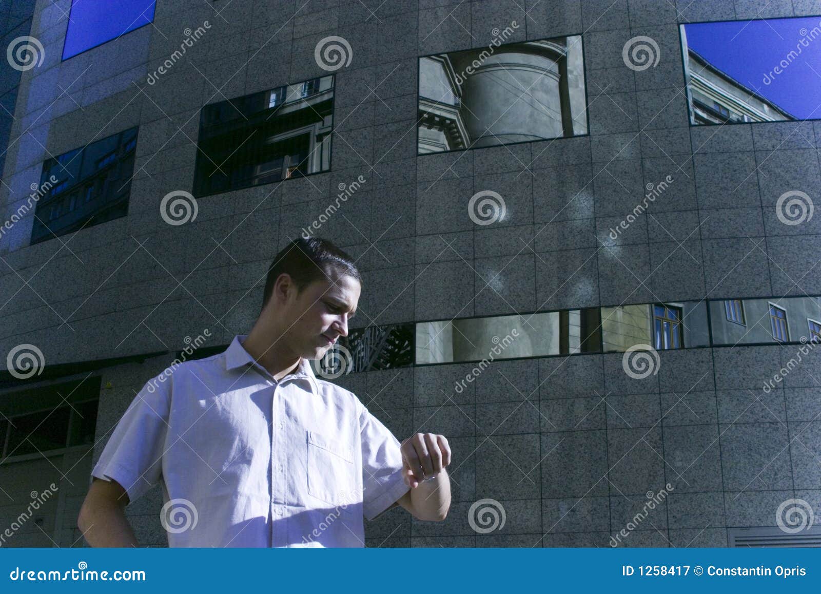 Businessman cheching time stock image. Image of handsome - 1258417