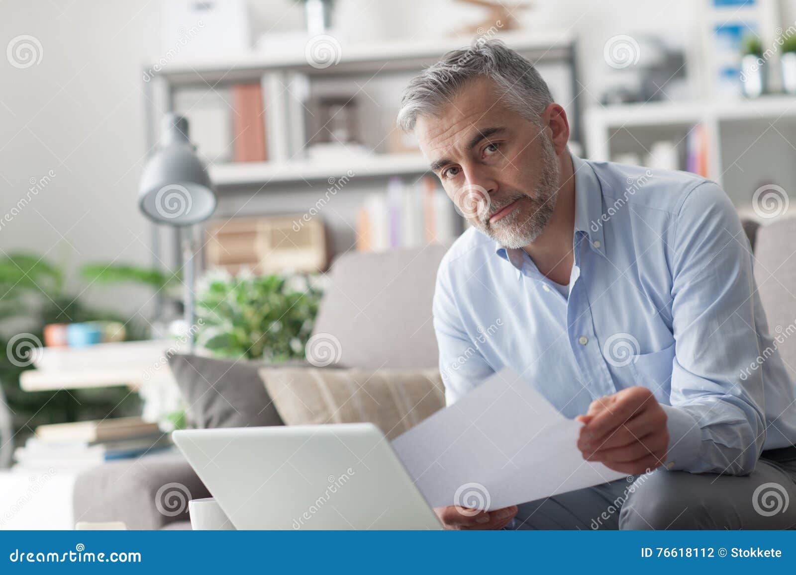 Businessman checking bills stock photo. Image of bills - 76618112