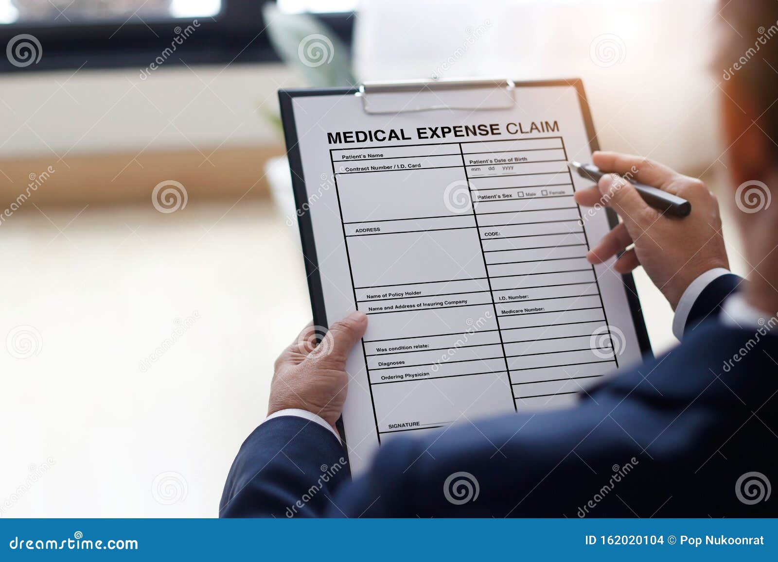 Businessman Checking Document and Completing a Insurance Claim Form at ...