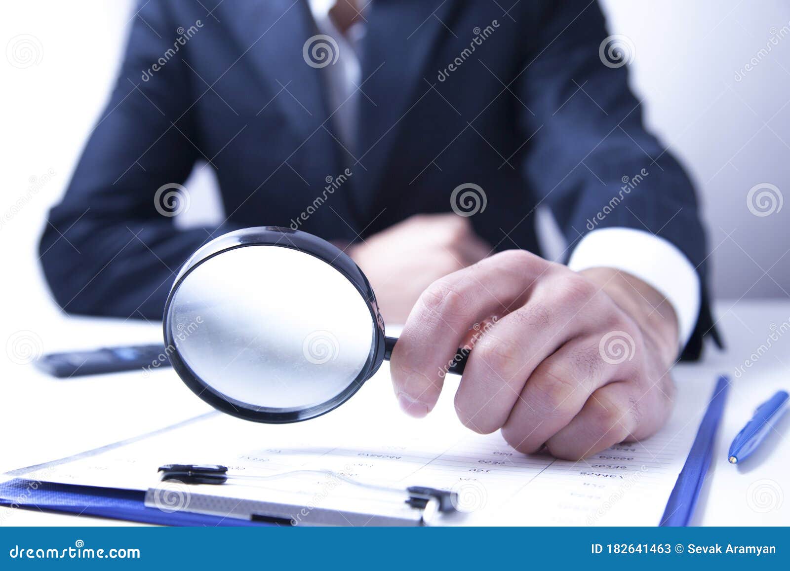 Businessman Checking a Document with a Magnifying Glass Stock Image ...