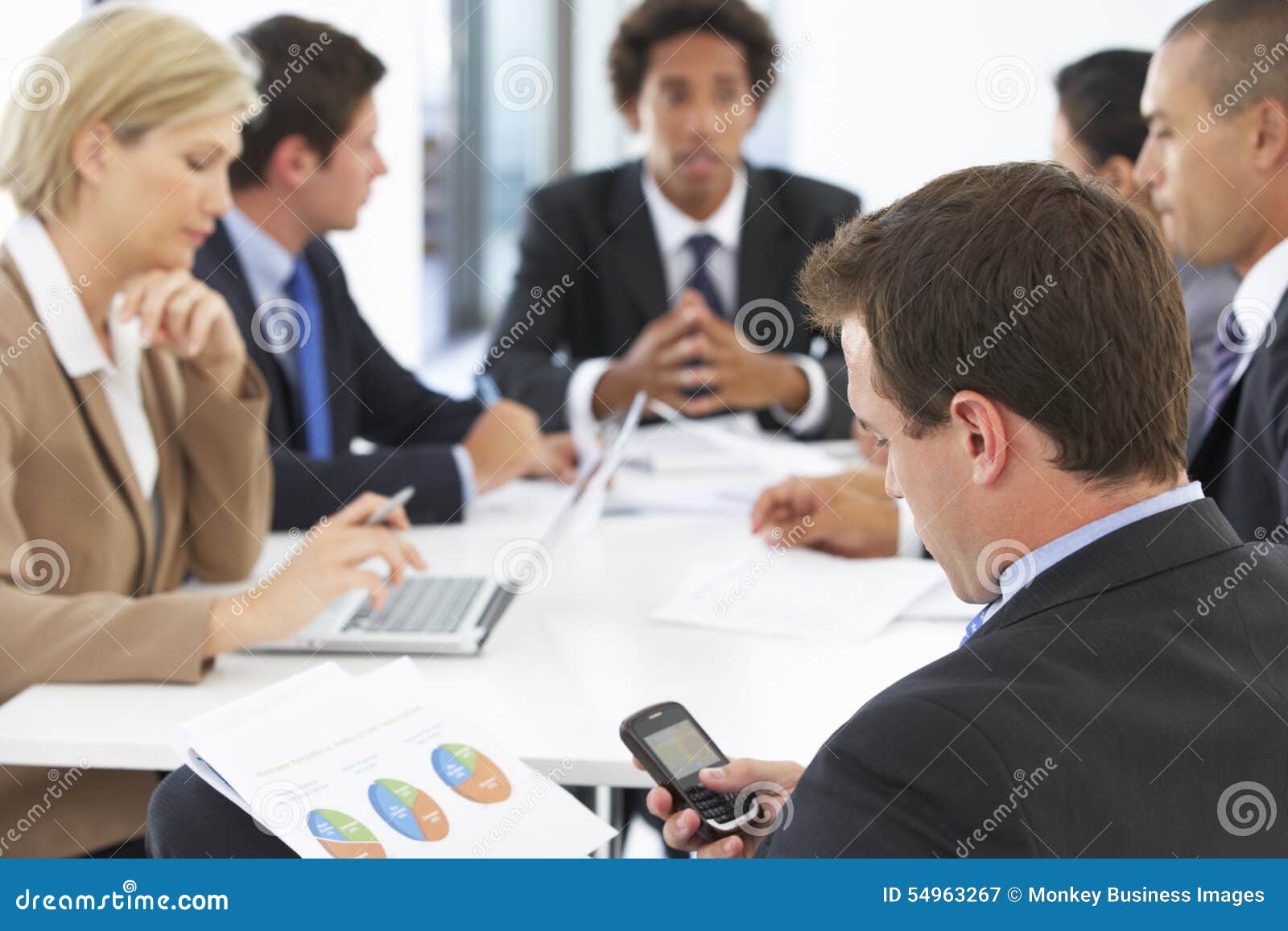 Businessman Checking Phone during Meeting in Office Stock Image - Image ...