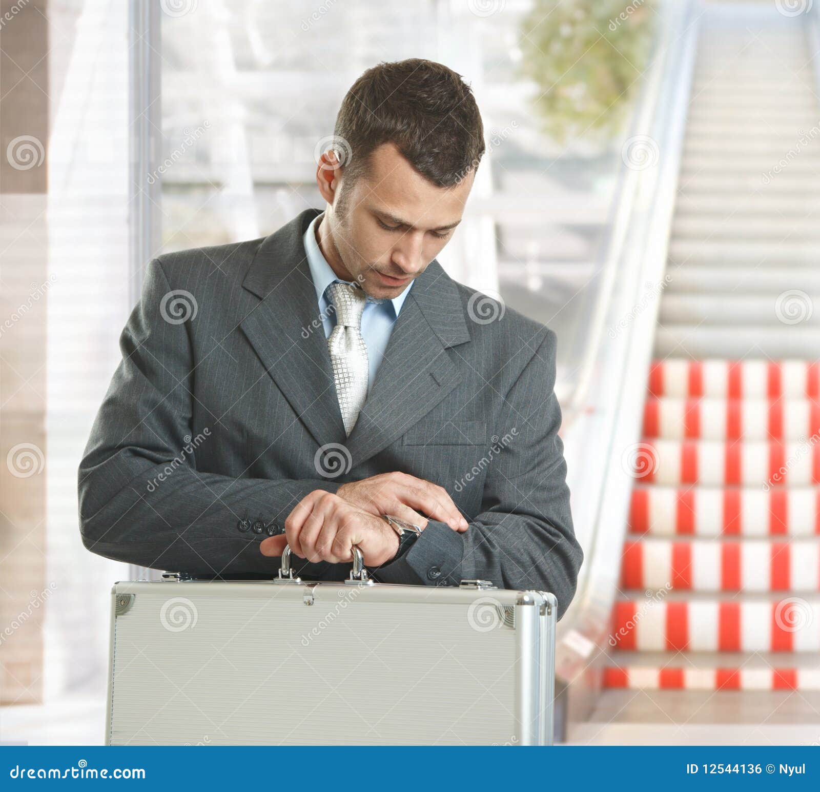 Businessman checking time stock photo. Image of hallway - 12544136