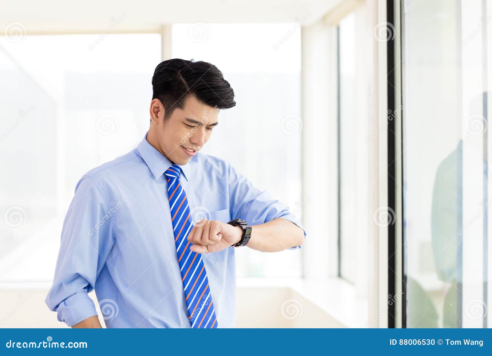 Businessman Checking Time from Watch in Office Stock Photo - Image of ...