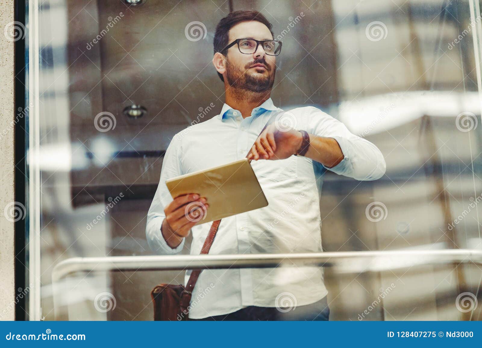 Businessman Checking Watch while Standing in Elevator Stock Image ...