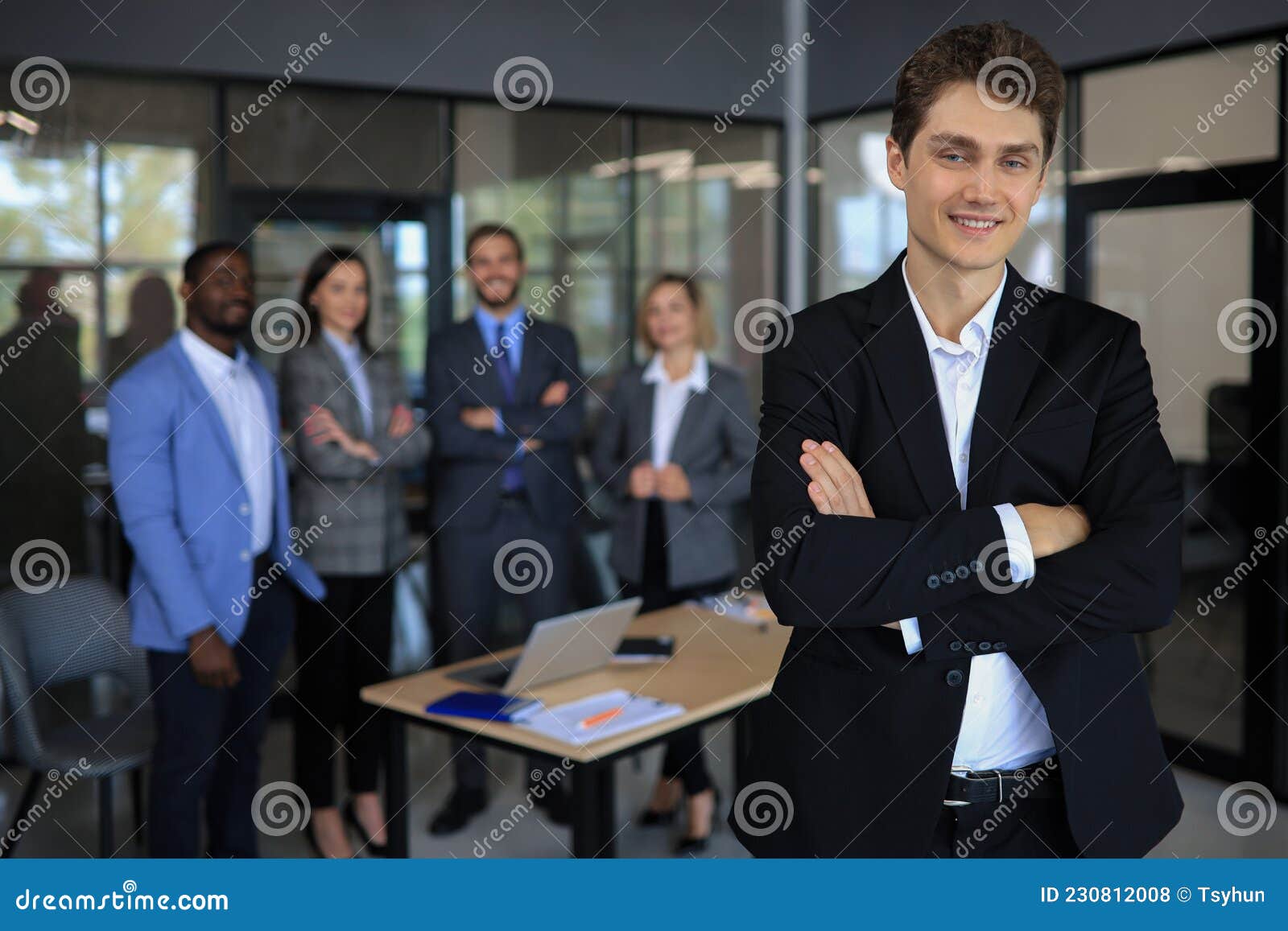Businessman with Colleagues in the Background in Office. Stock Photo ...