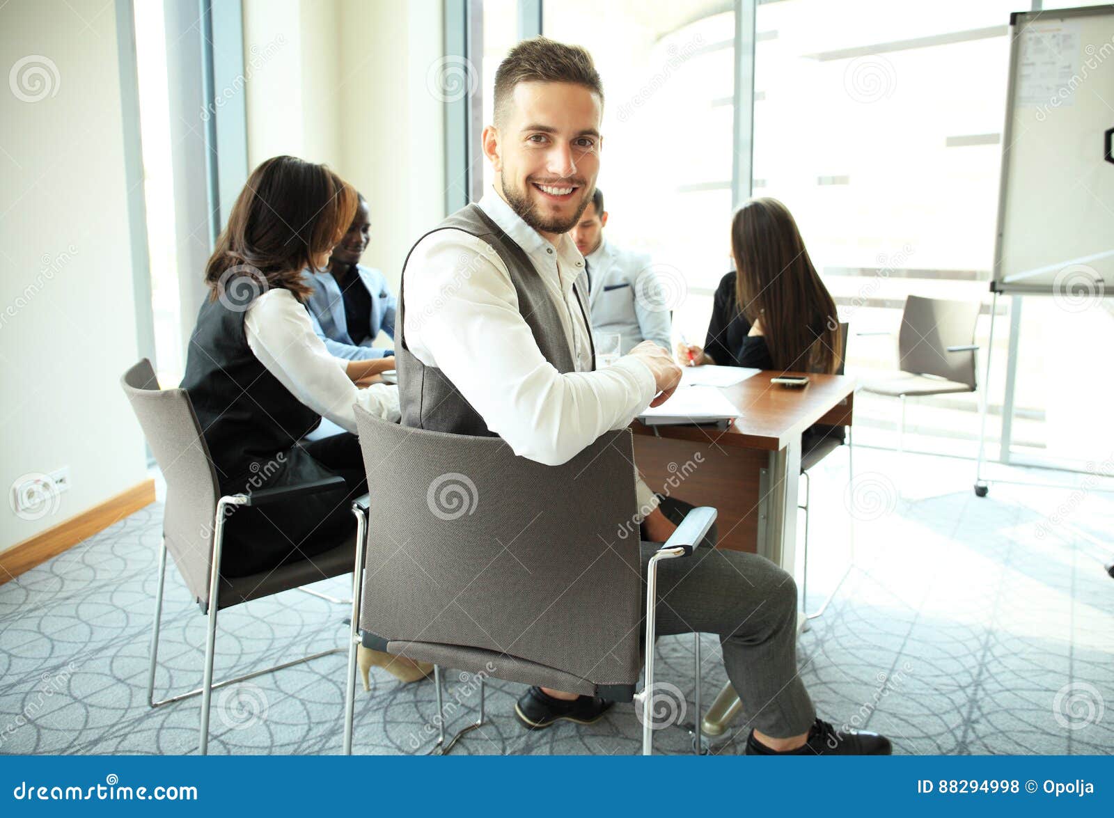 Businessman with Colleagues in the Background in Office. Stock Photo ...
