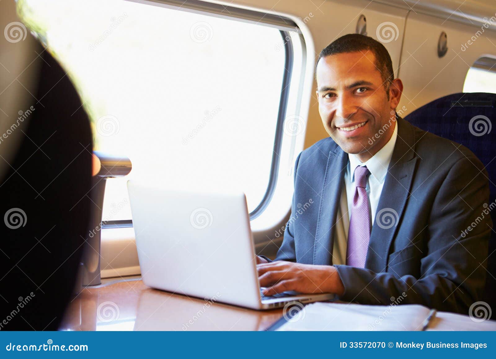 Businessman Commuting To Work on Train and Using Laptop Stock Photo ...