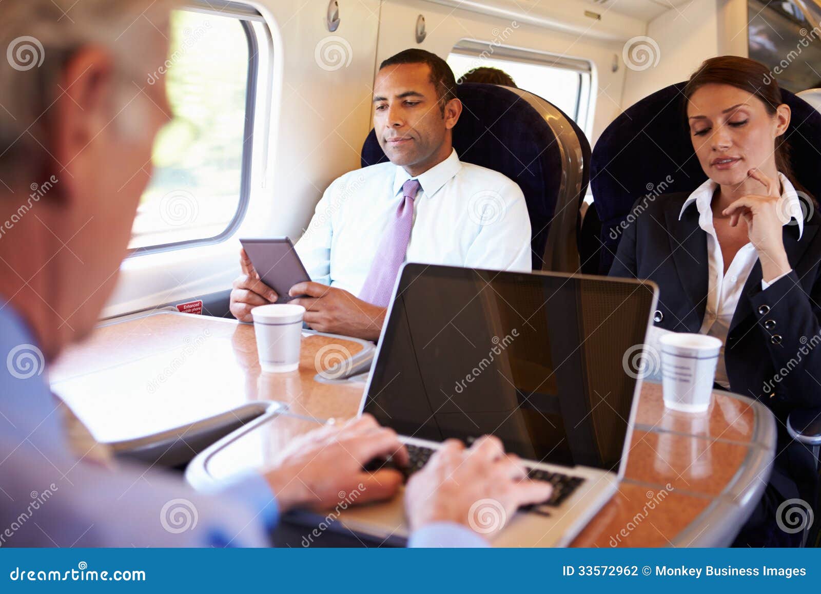 Businessman Commuting To Work on Train and Using Laptop Stock Photo ...