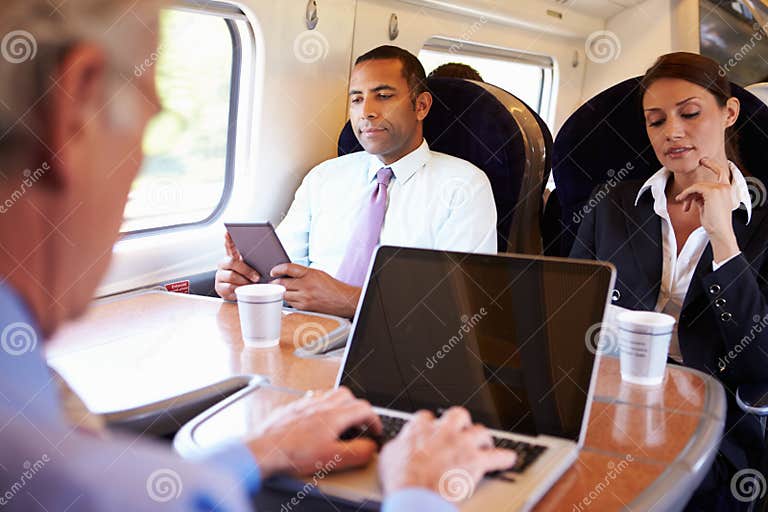 Businessman Commuting To Work on Train and Using Laptop Stock Photo ...